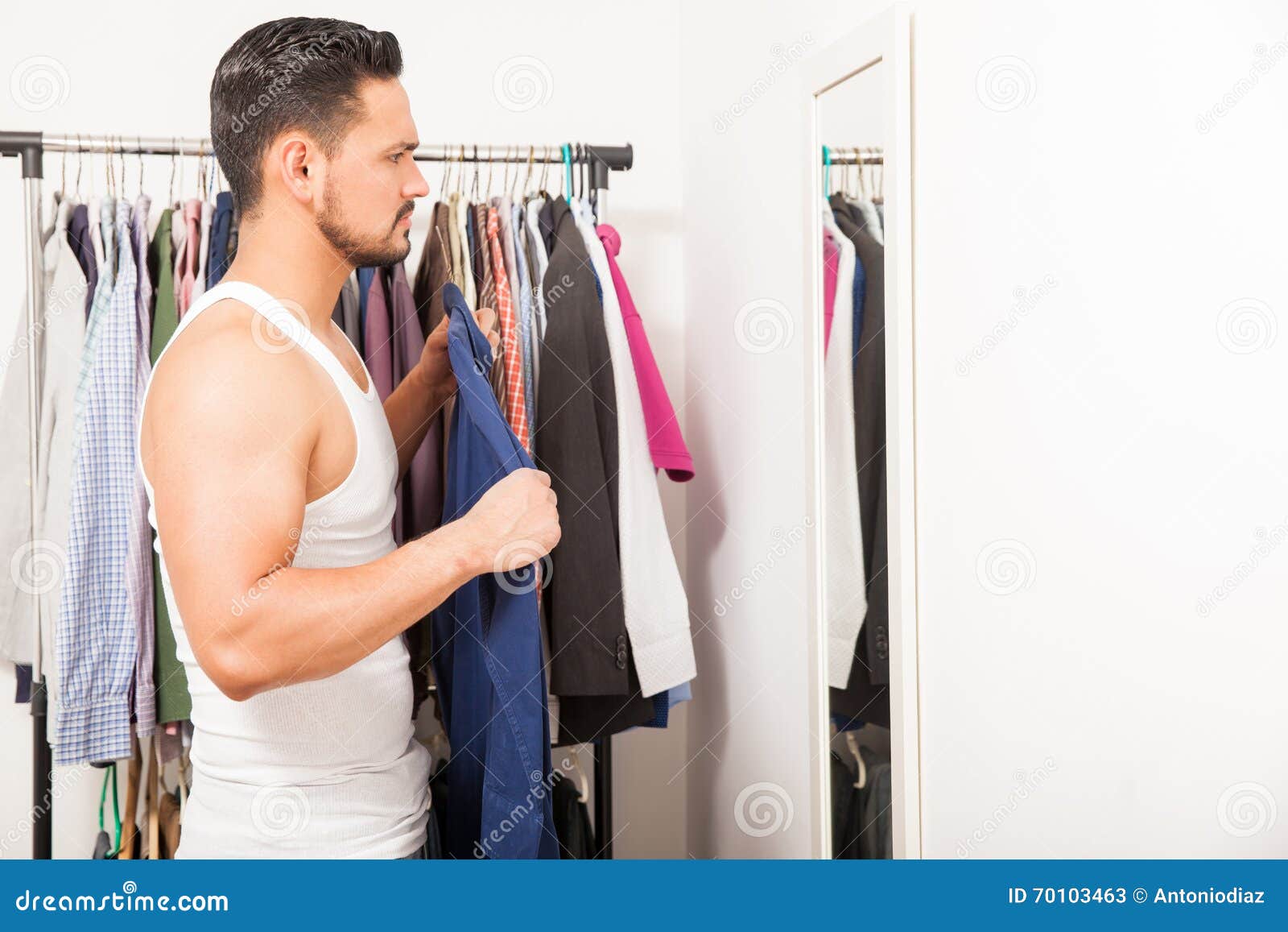 Young Man Trying on a Shirt Stock Image - Image of mirror, sale: 70103463