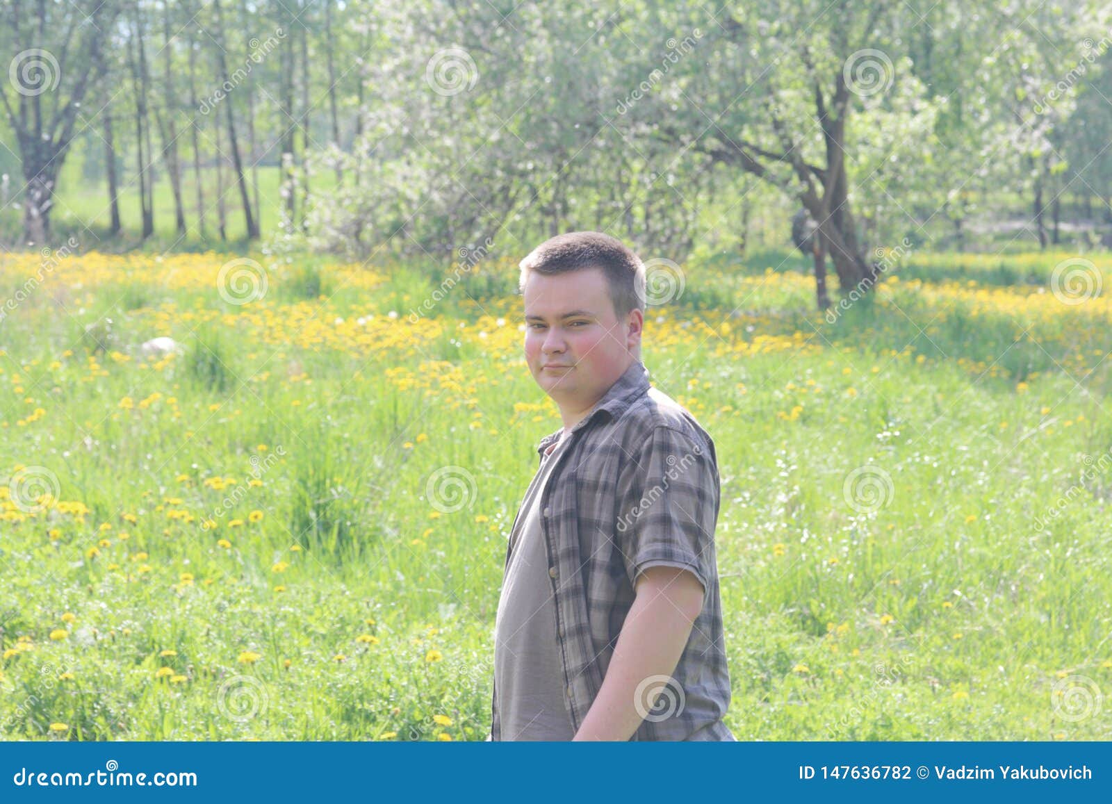 The Young Man Turned Back, Walking Along a Spring Meadow with Lush ...