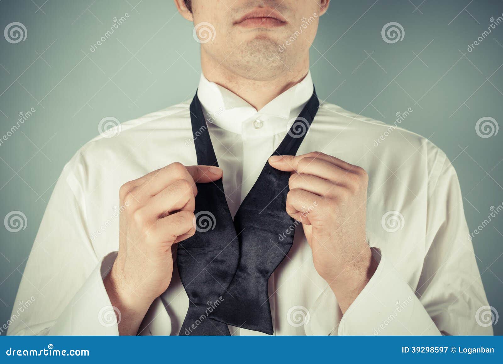 Young man tying a bow tie stock image. Image of suit - 39298597