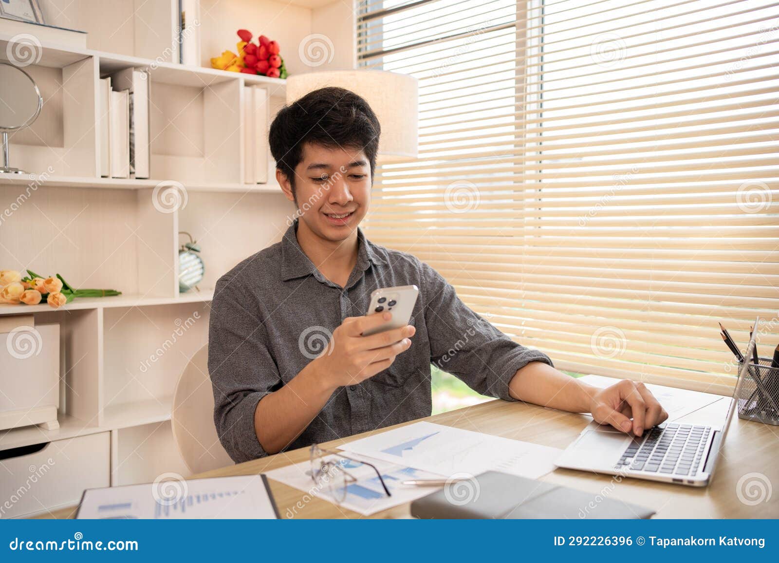 Young Man Typing Chat or Message on Mobile Phone with Smiling Face ... Young Man Typing Chat or Message on Mobile Phone with Smiling Face ...