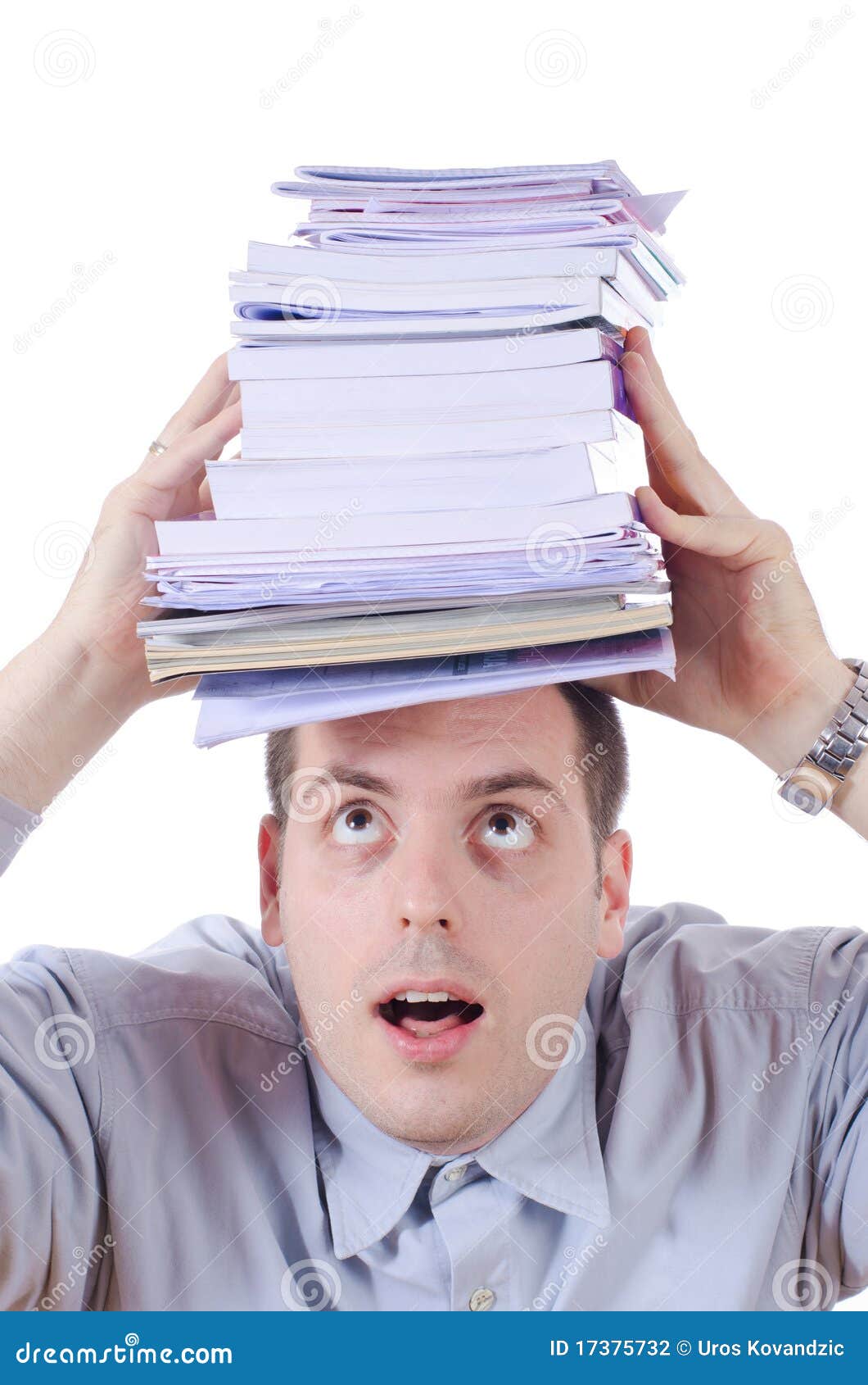 Young Man Under a Pile of Books on His Head Stock Photo - Image of ...
