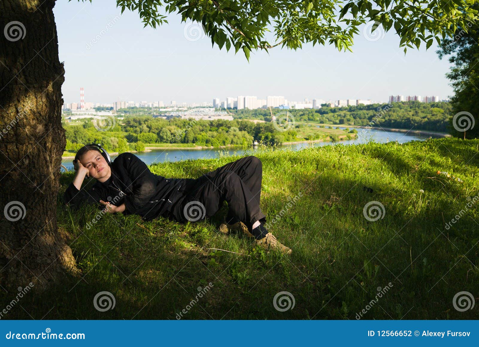 Young Man Under the Tree stock photo. Image of modern - 12566652