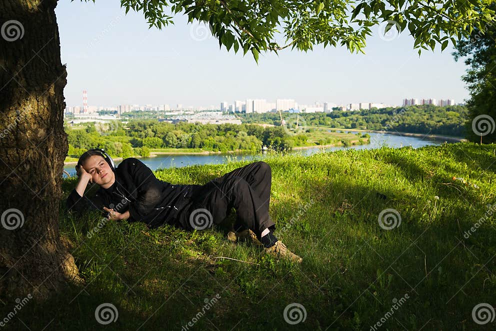 Young Man Under the Tree stock photo. Image of modern - 12566652