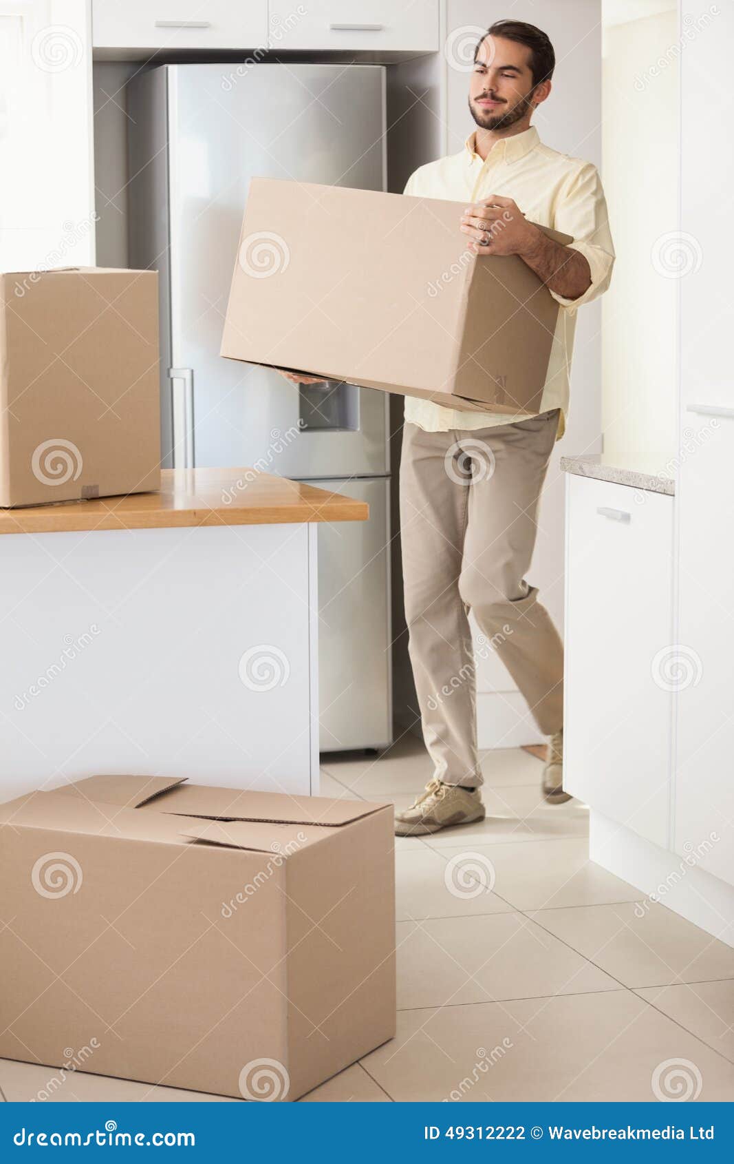 Young Man Unpacking Boxes in Kitchen Stock Photo - Image of male, adult ...