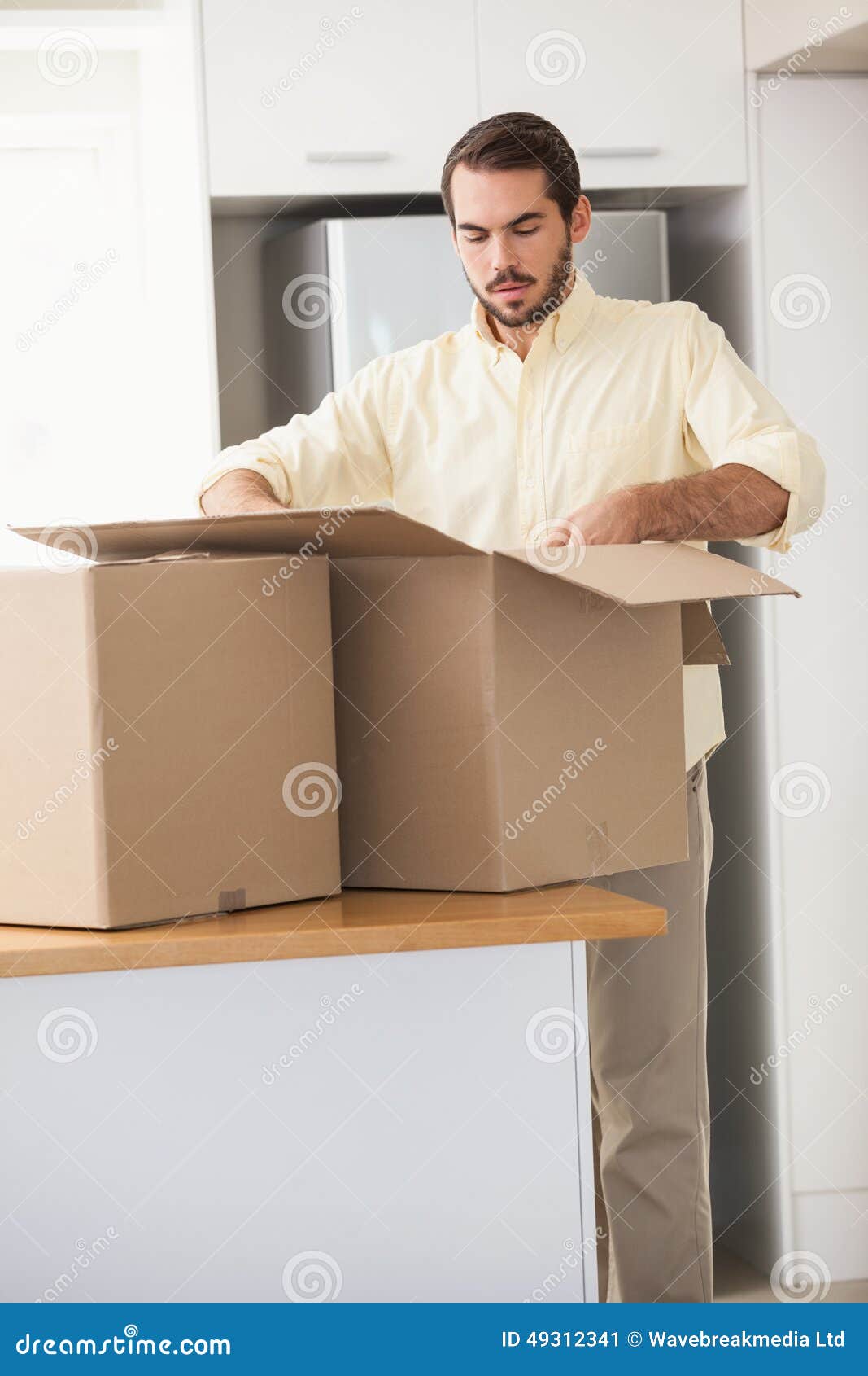 Young Man Unpacking Boxes in Kitchen Stock Image - Image of person ...
