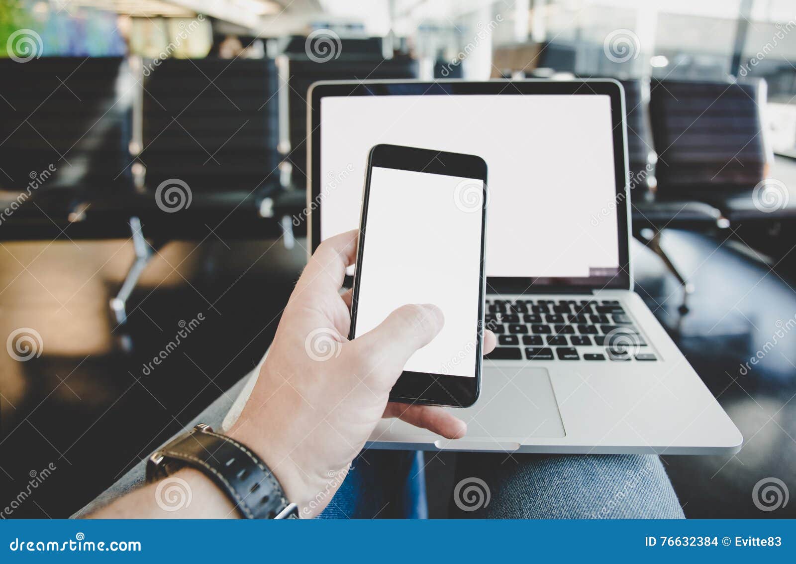 Young Man Use Notebook or Laptop Computer and Phone in the Airport ...