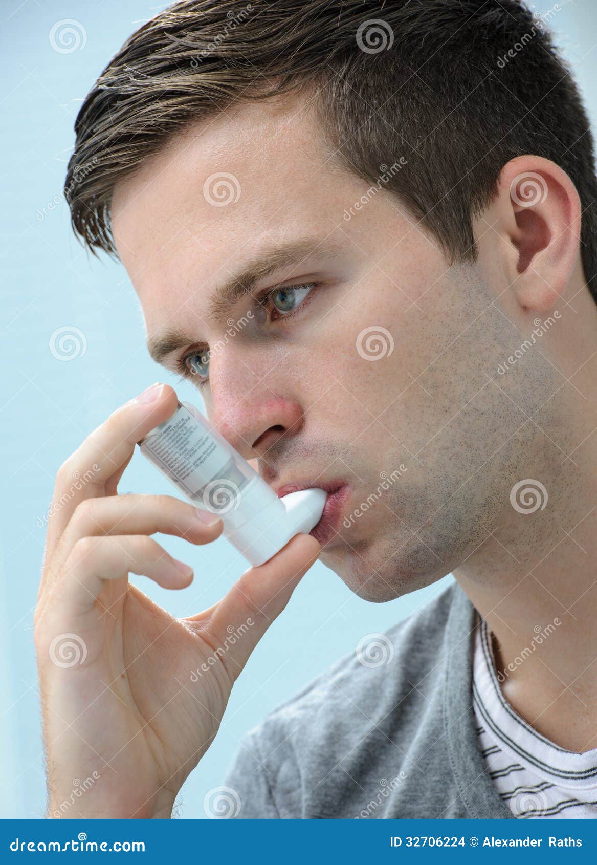 Young Man Using an Asthma Inhaler Stock Photo - Image of adult, inhaler ...