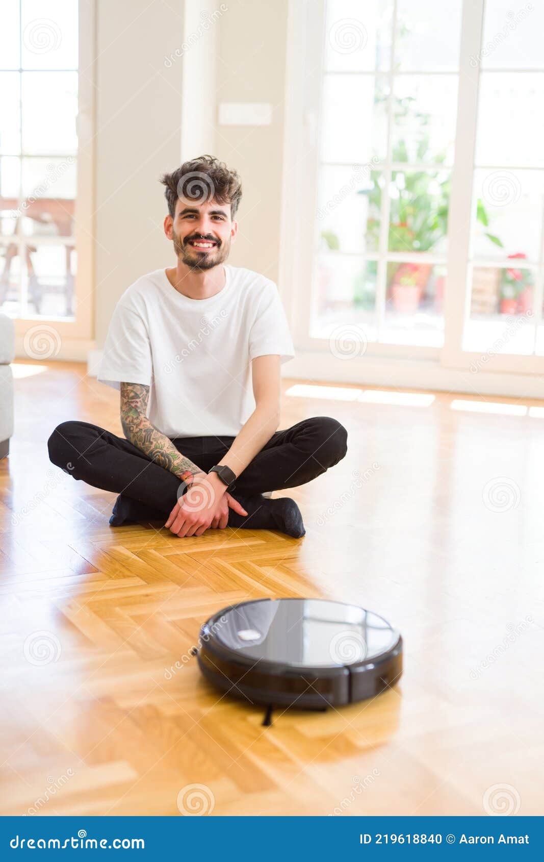 Young Man Using Automatic Vacuum Cleaner To Clean the Floor, Controling ...