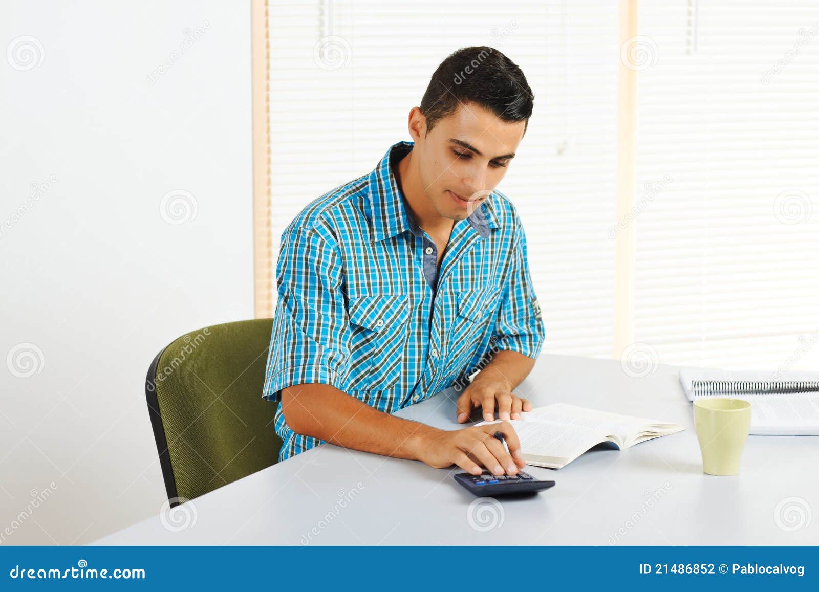 Young Man Using a Calculator Stock Photo - Image of happy, environmant ... Young Man Using a Calculator Stock Photo - Image of happy, environmant ...