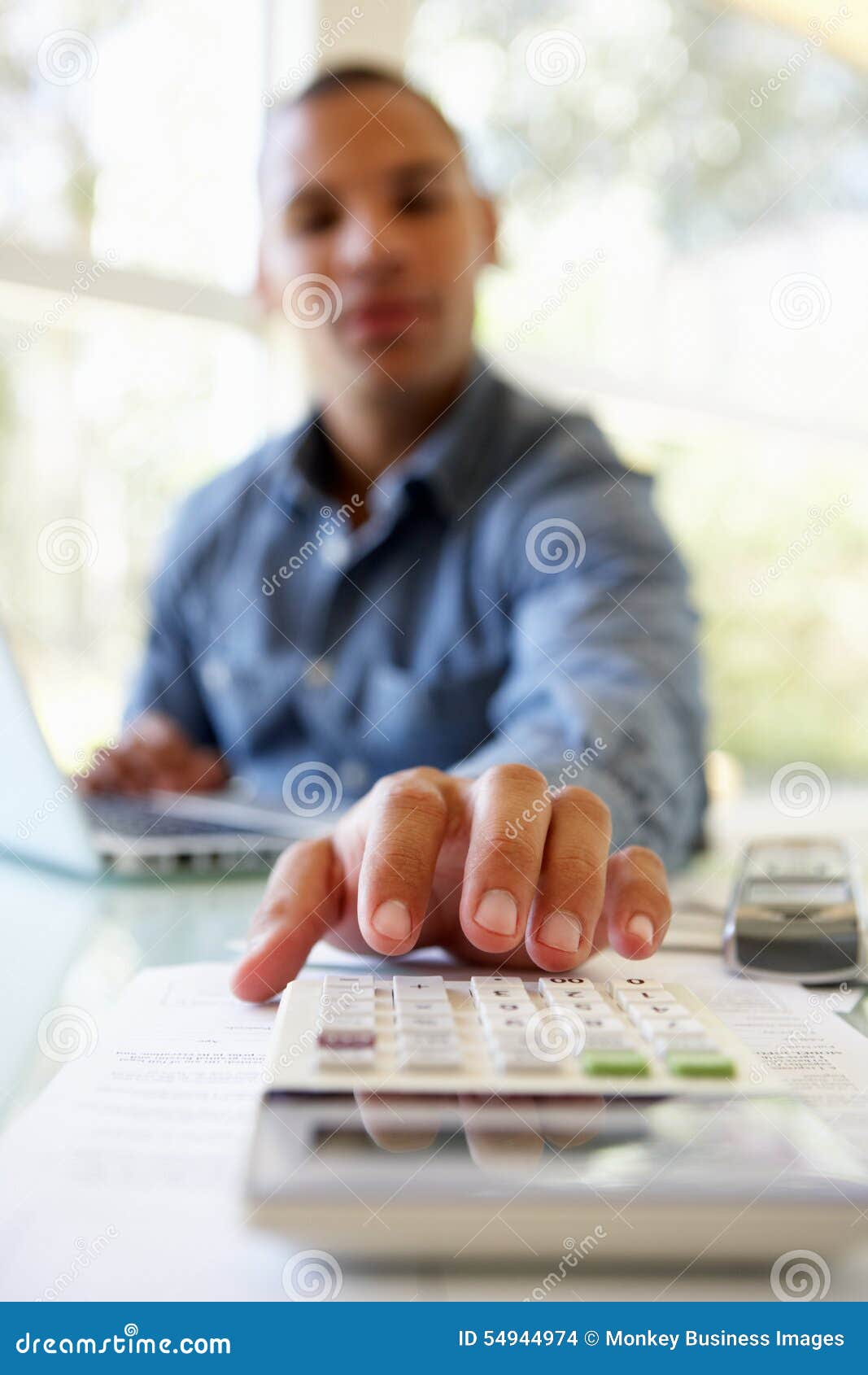 Young Man on Using Calculator at Home Stock Photo - Image of ...