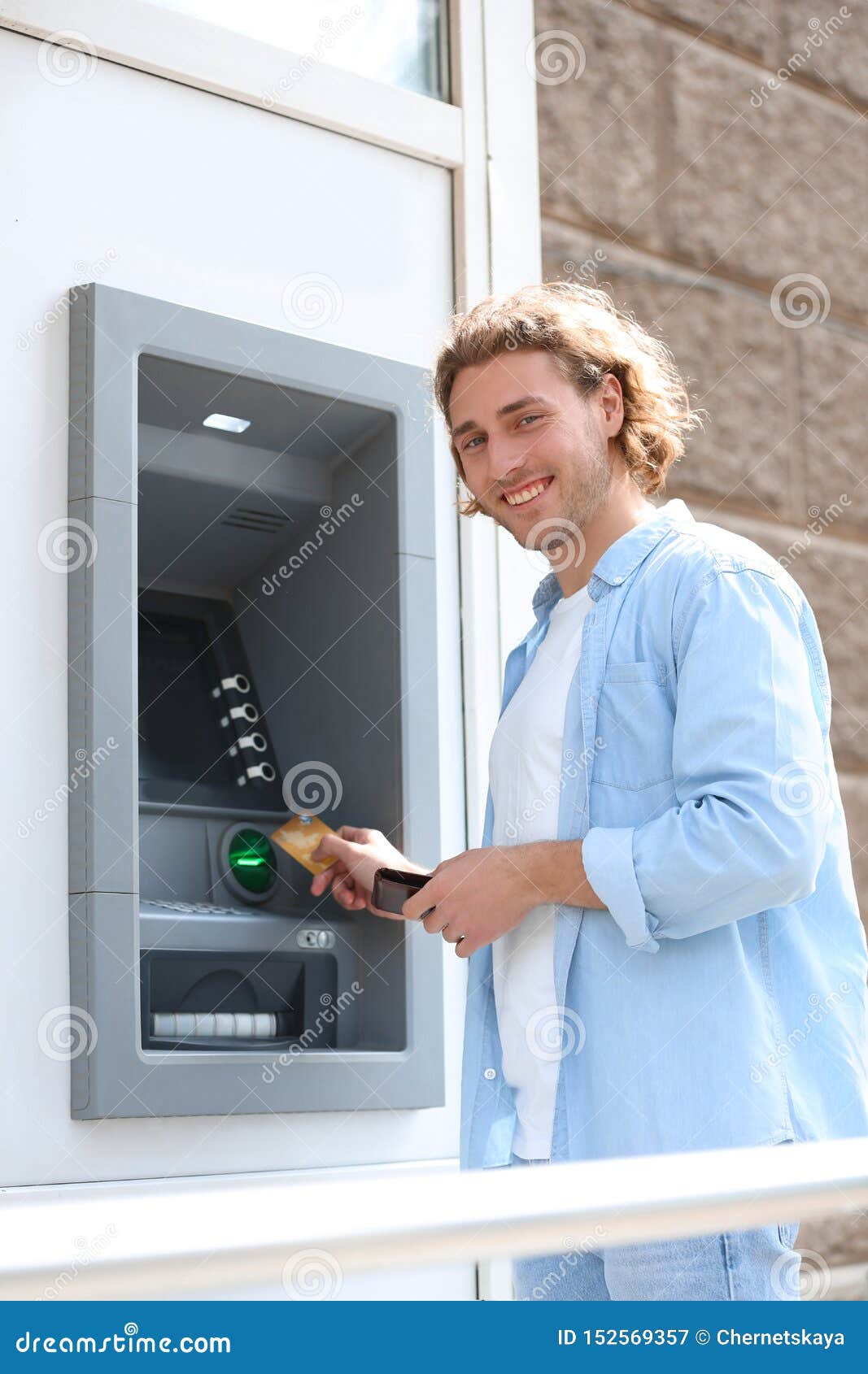 Young Man Using Cash Machine for Money Withdrawal Stock Image - Image ...