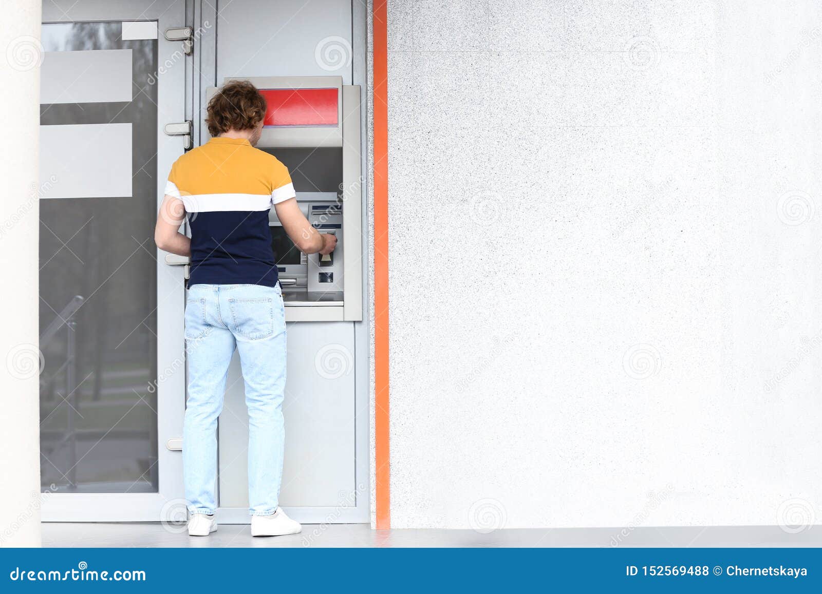 Young Man Using Cash Machine Outdoors Stock Photo - Image of back ...