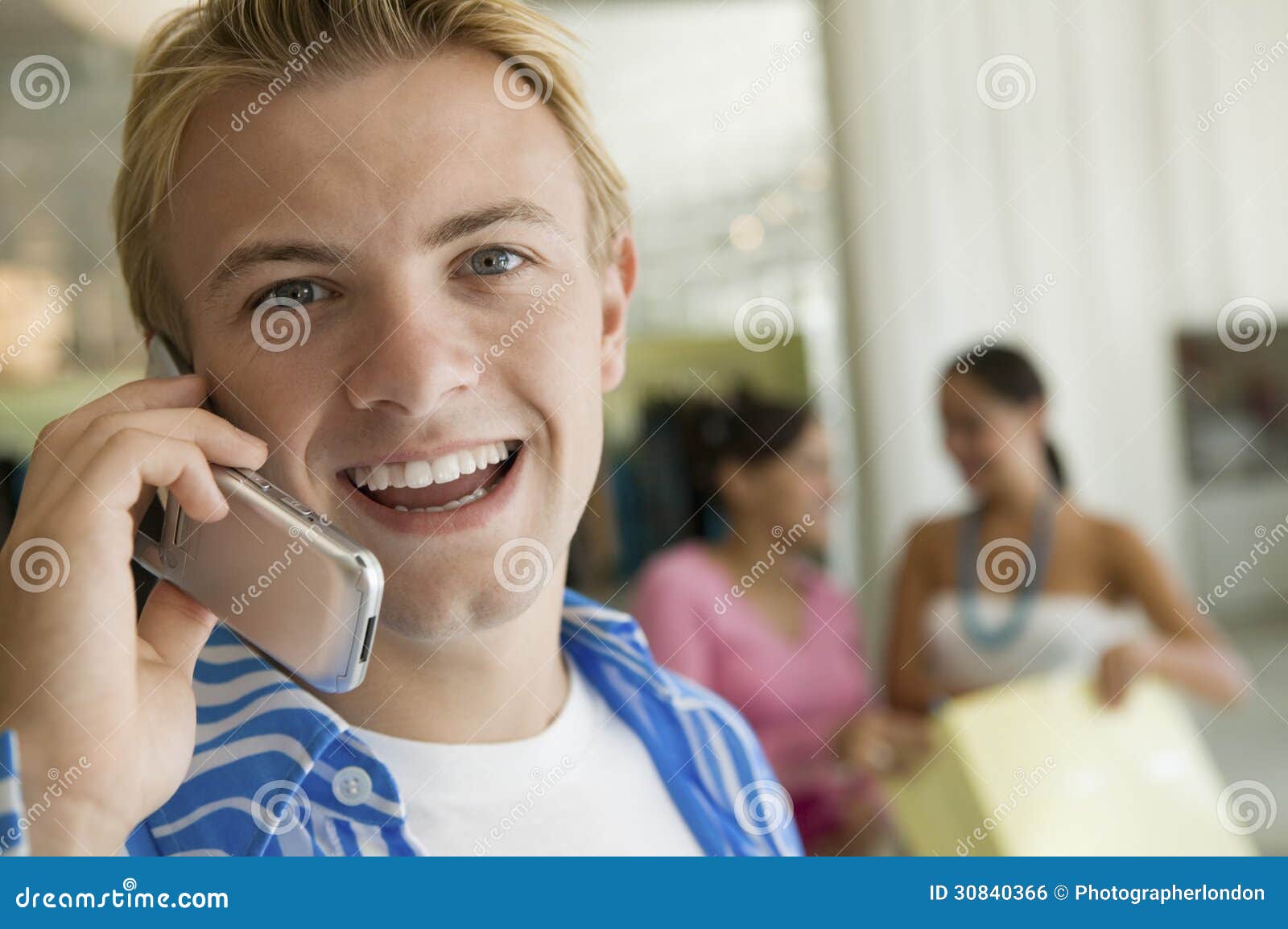 Young Man Using Cell Phone in Clothing Store Portrait Close Up Stock ...