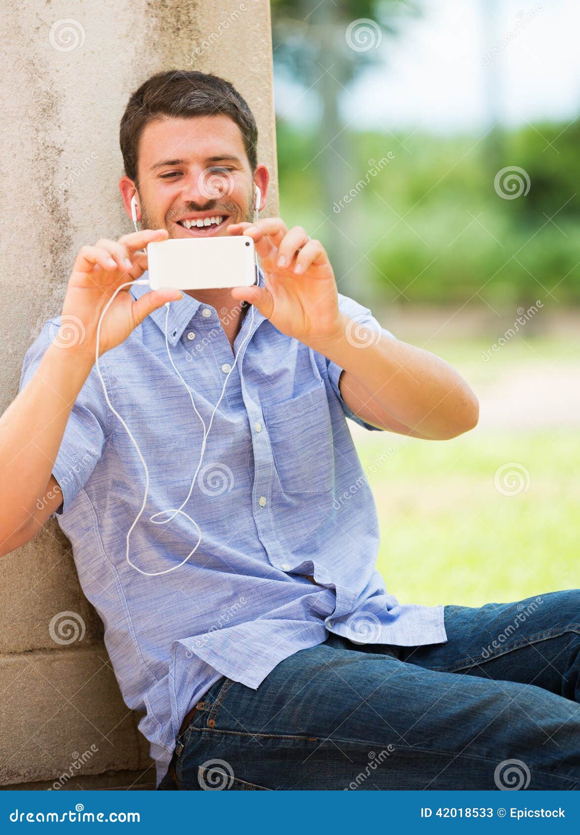 Young man using cell phone stock image. Image of relaxing - 42018533
