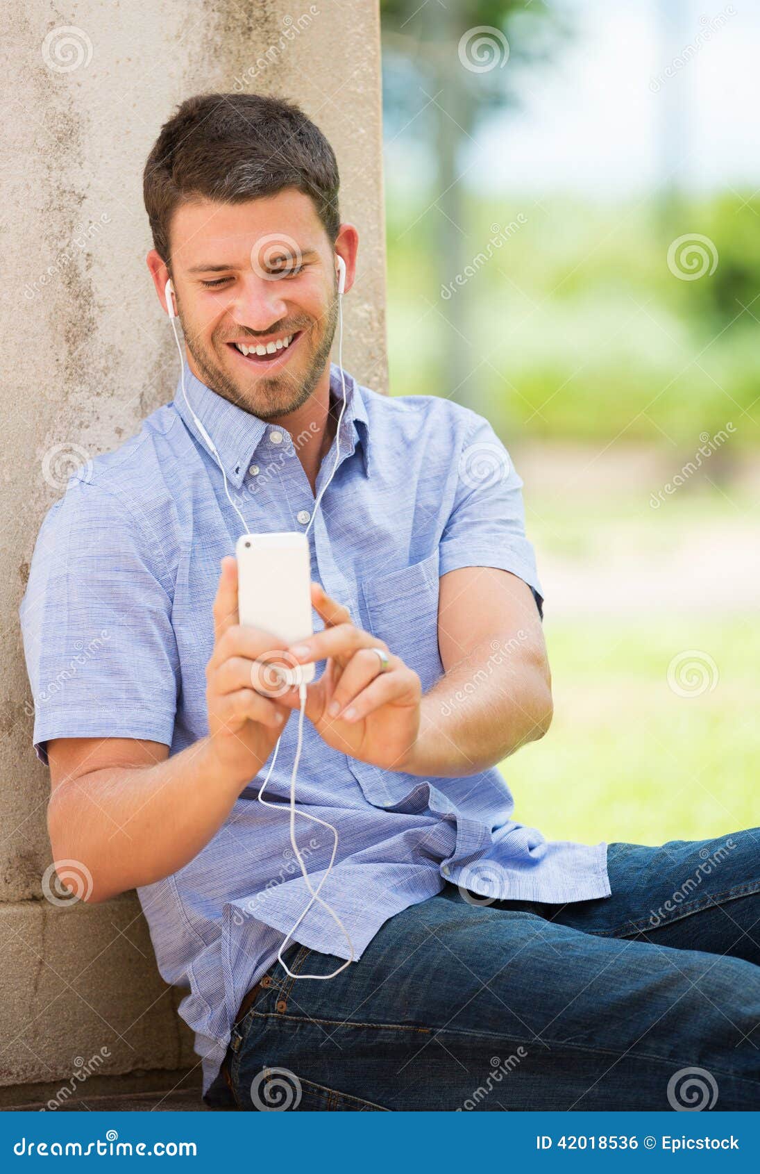 Young man using cell phone stock photo. Image of sitting - 42018536