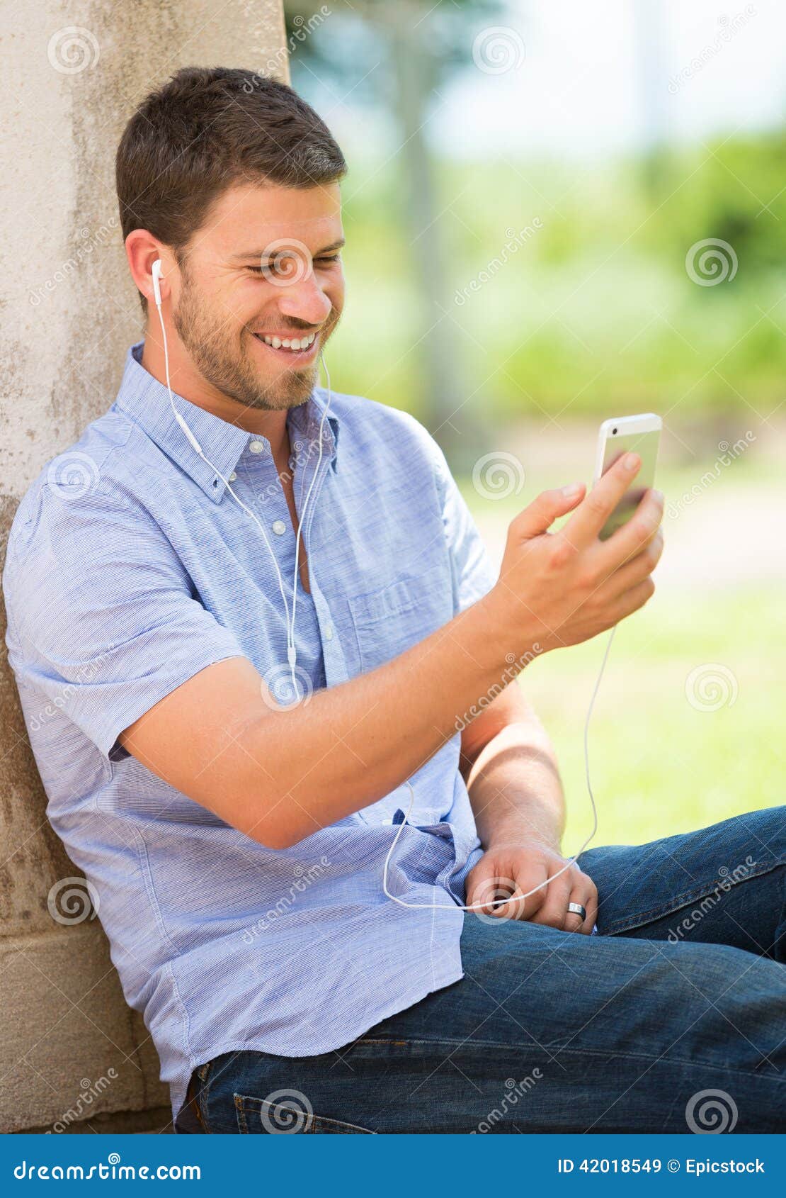 Young man using cell phone stock image. Image of outside - 42018549