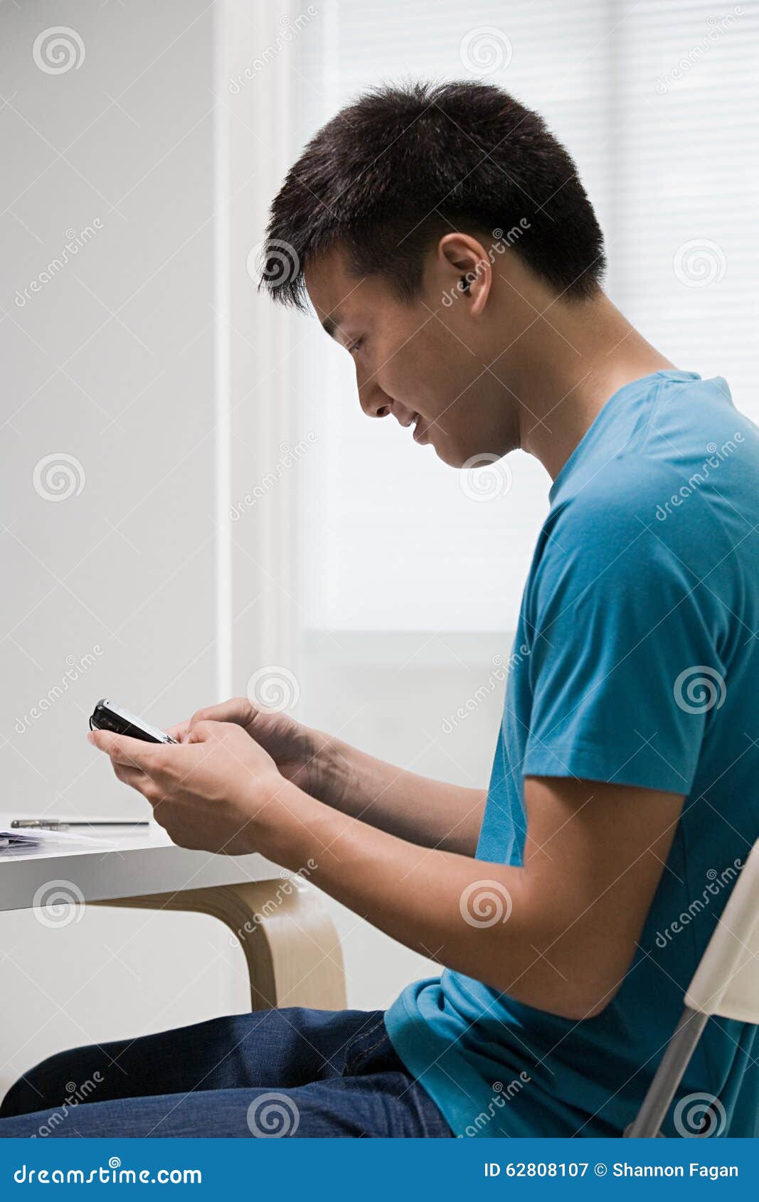 Young man using cellphone stock image. Image of business - 62808107