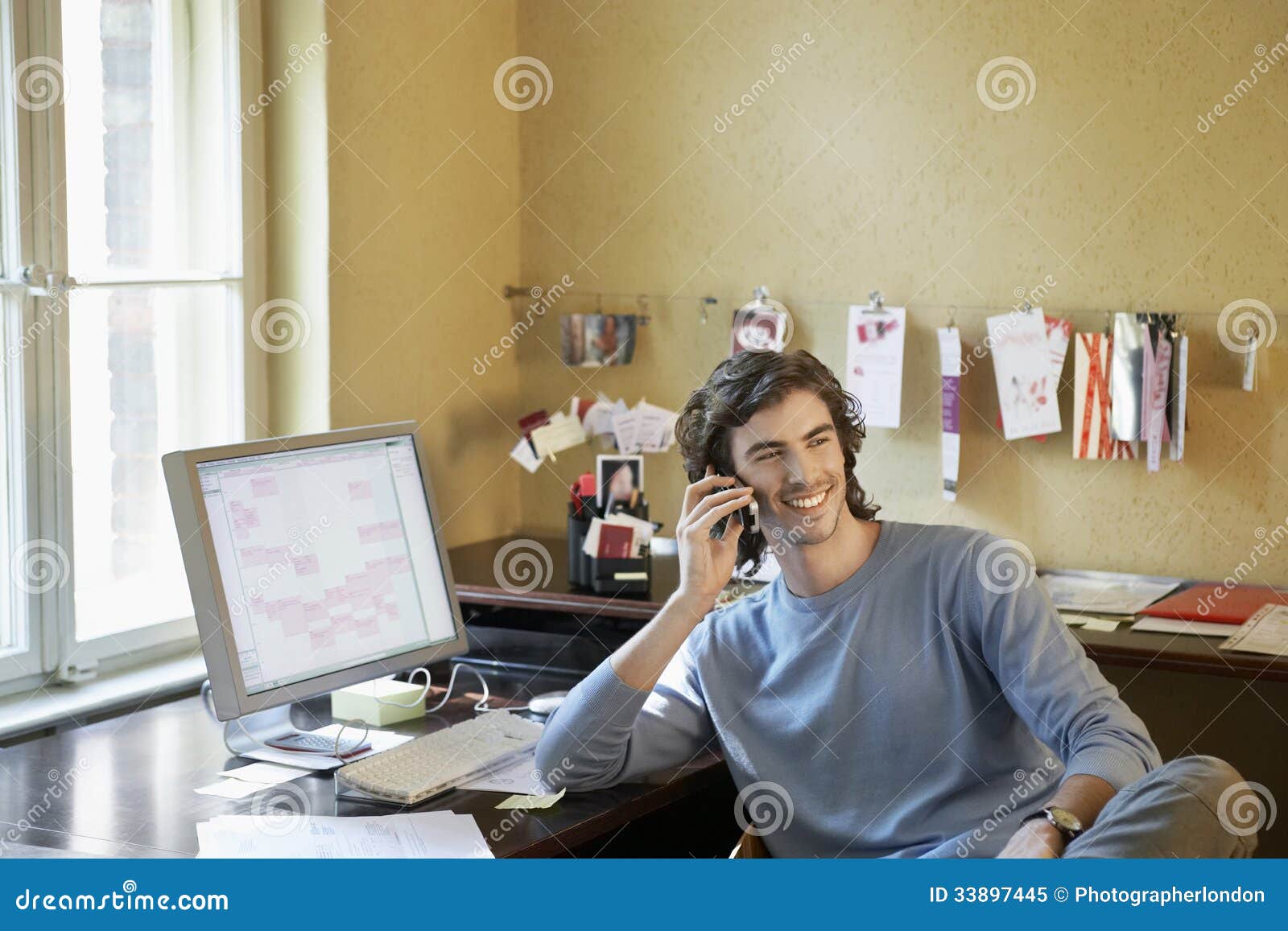 Young Man Using Cellphone in Office Stock Image - Image of casual ...