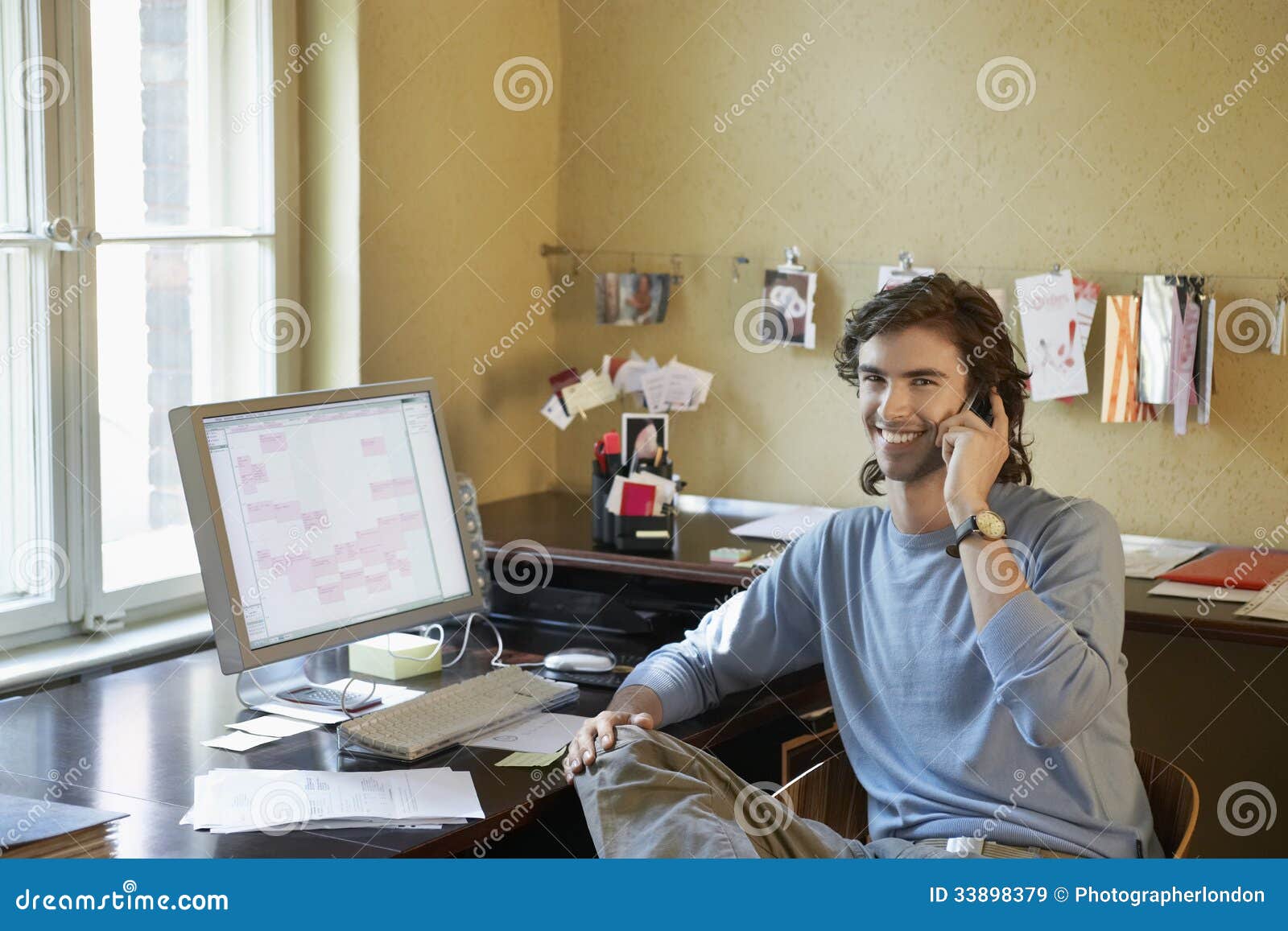 Young Man Using Cellphone in Office Stock Image - Image of desk ...