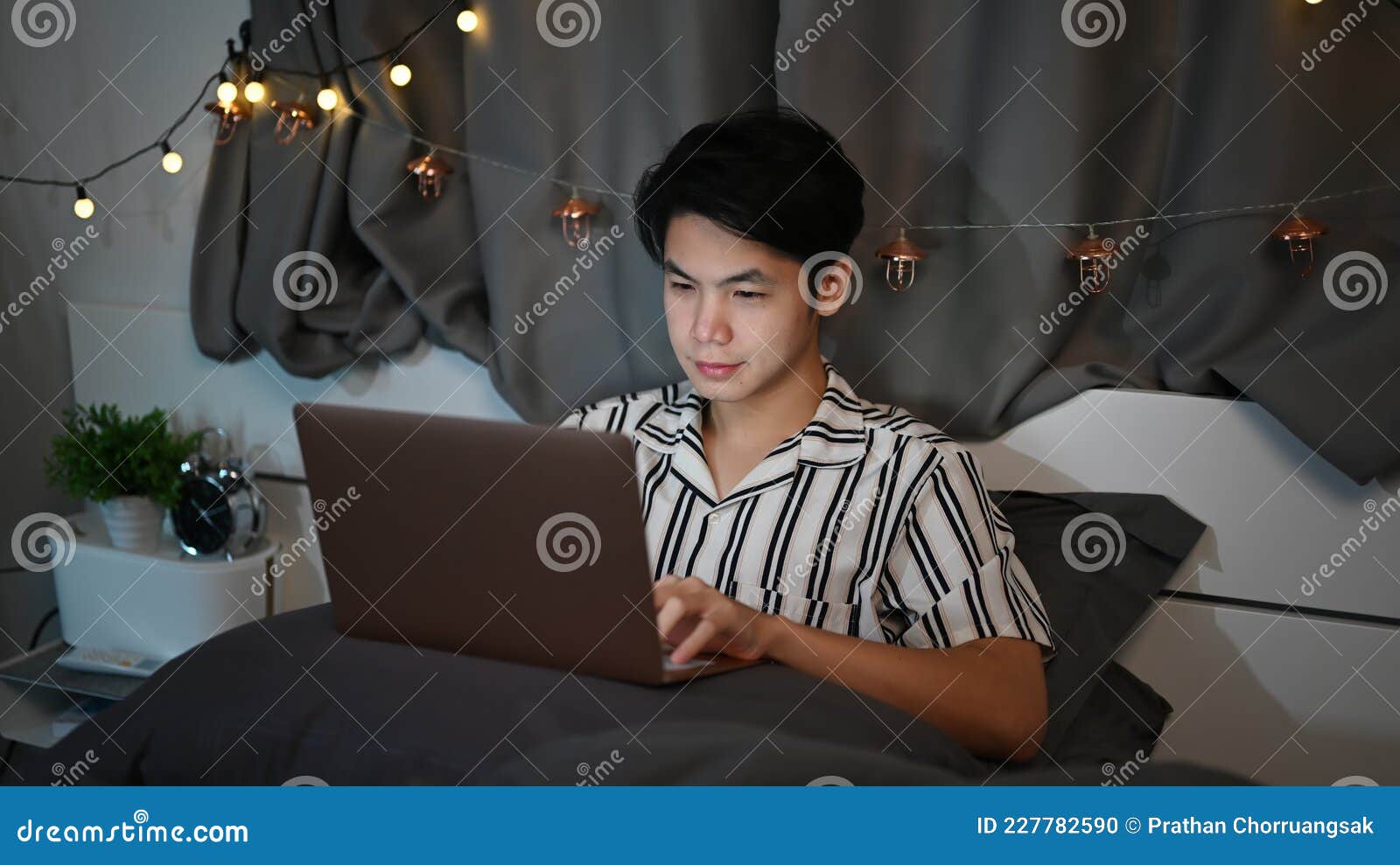 Young Man Using Computer Laptop in His Bed at Night. Stock Photo ...