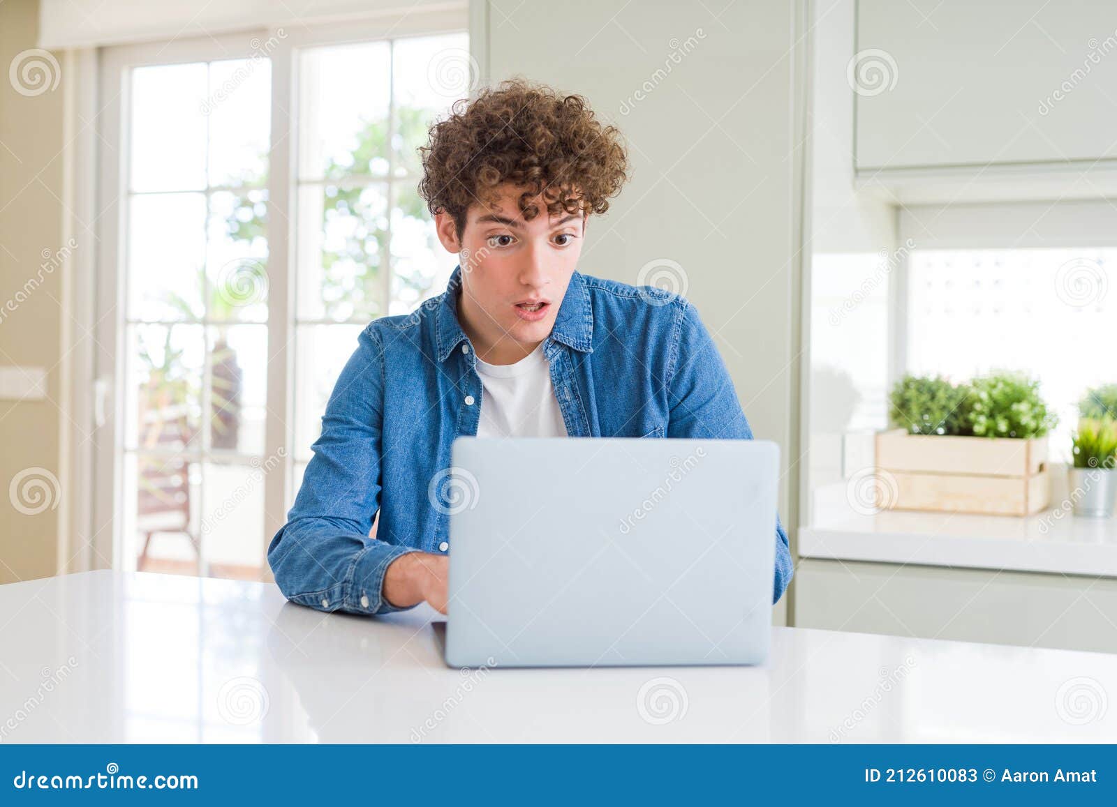 Young Man Using Computer Laptop Scared in Shock with a Surprise Face ...