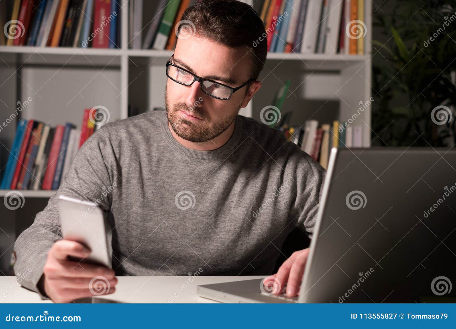 Young Man Using Computer Laptop and Smart Phone Stock Image - Image of ...