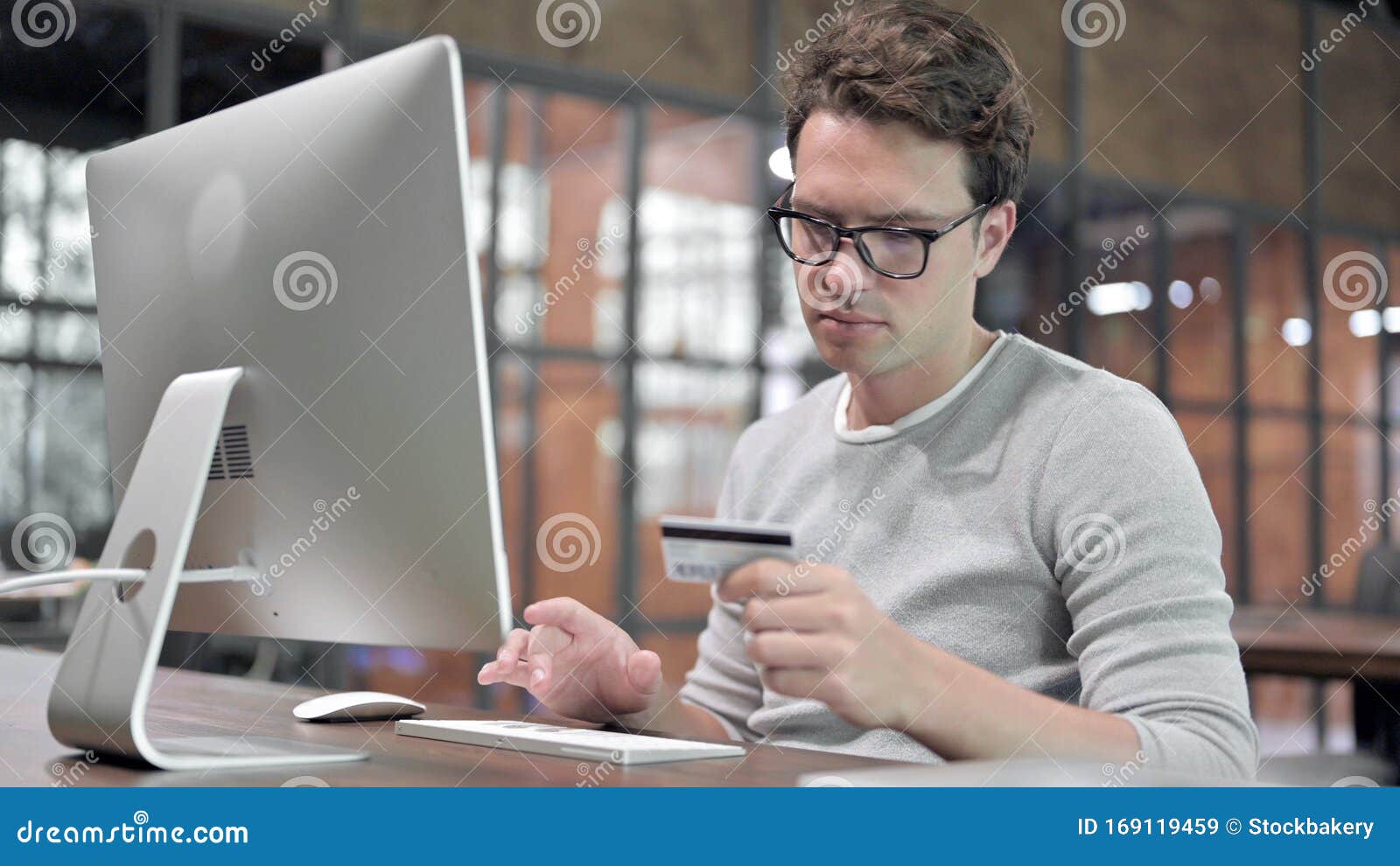 Young Man Using Credit Card for Payment on Computer Stock Image - Image ...