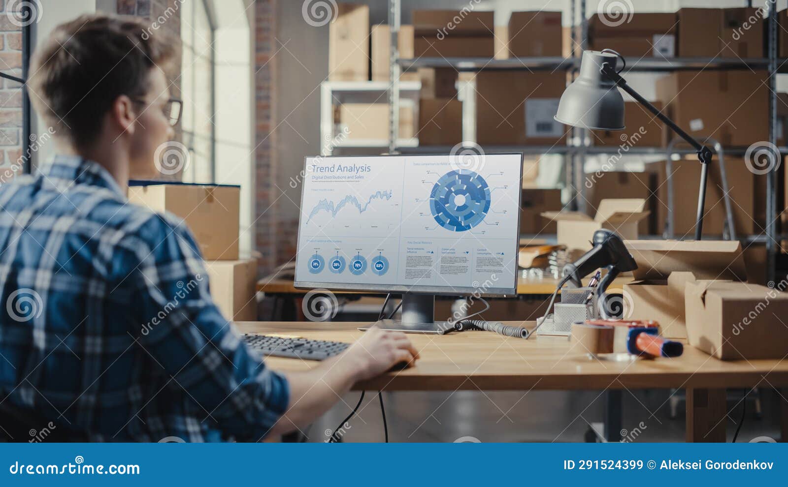 Young Man Using Desktop Computer with a Trend Analysis Charts Display ...