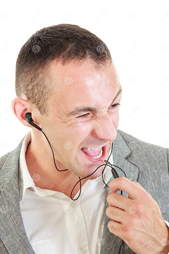Young Man Using Earbuds Shouting on Microphone Stock Image - Image of ...