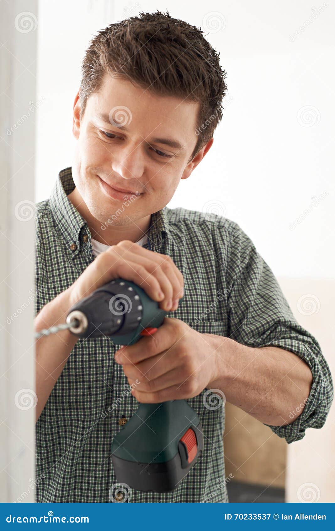 Young Man Using Electric Drill in House Renovation Project Stock Image ...