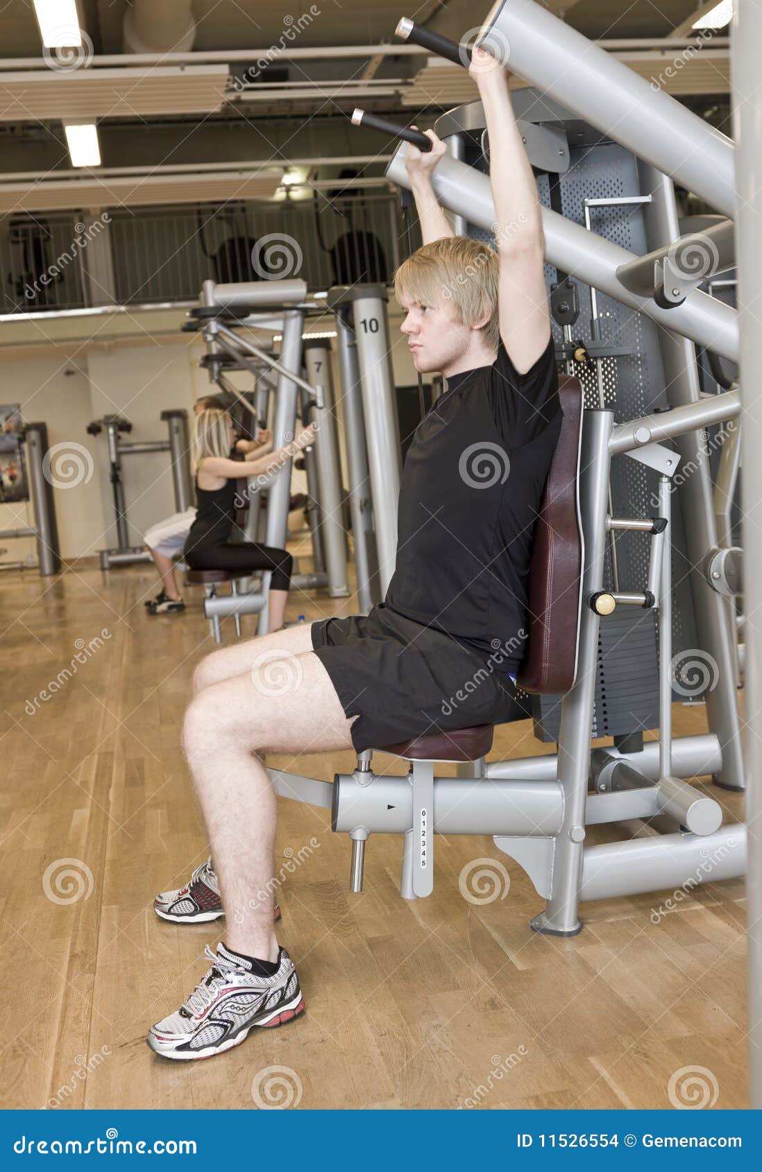 Young Man Using an Exercise Machine Stock Photo - Image of human, flys ...