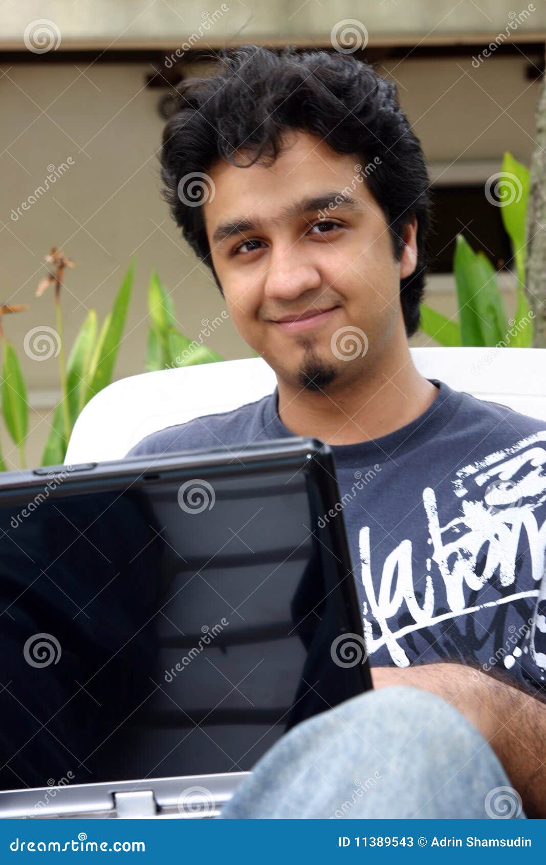 A Young Man Using His Laptop Stock Image - Image of student, sitting ...