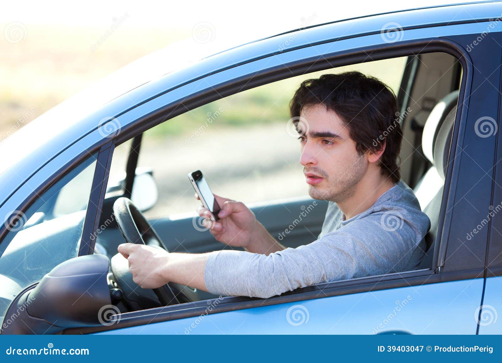 Young Man Using His Smartphone while Driving Stock Image - Image of ...