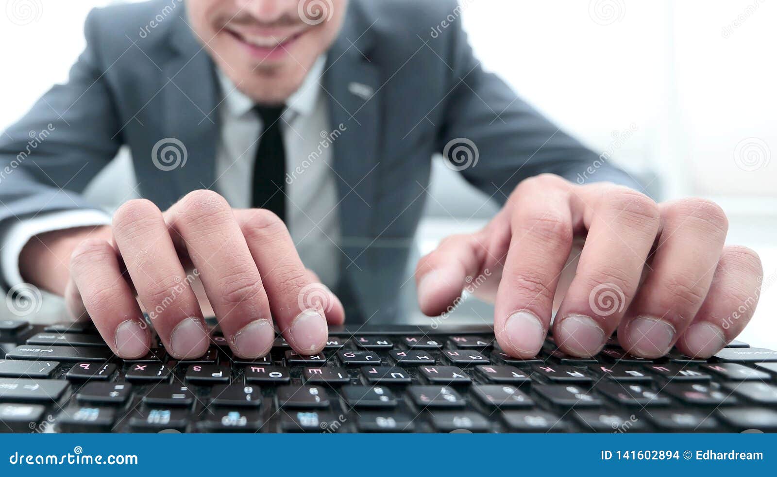 Young Man Using Keyboard , Closely and Carefully Looking at the Camera ...