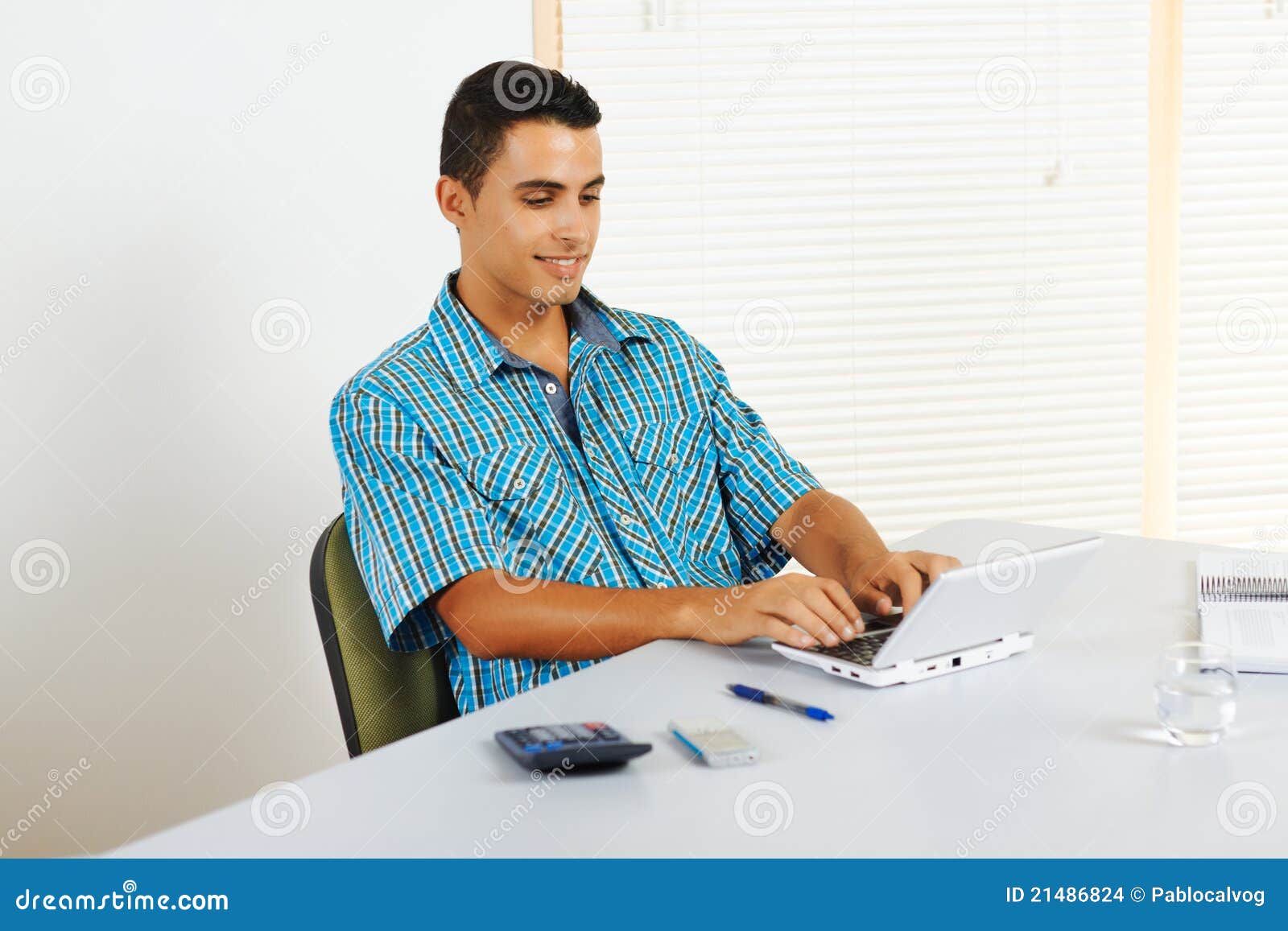 Young man using a laptop stock photo. Image of coworkers - 21486824