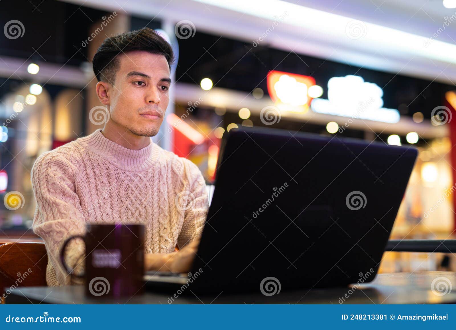 Young Man Using Laptop Computer at Coffee Shop Stock Image - Image of ...
