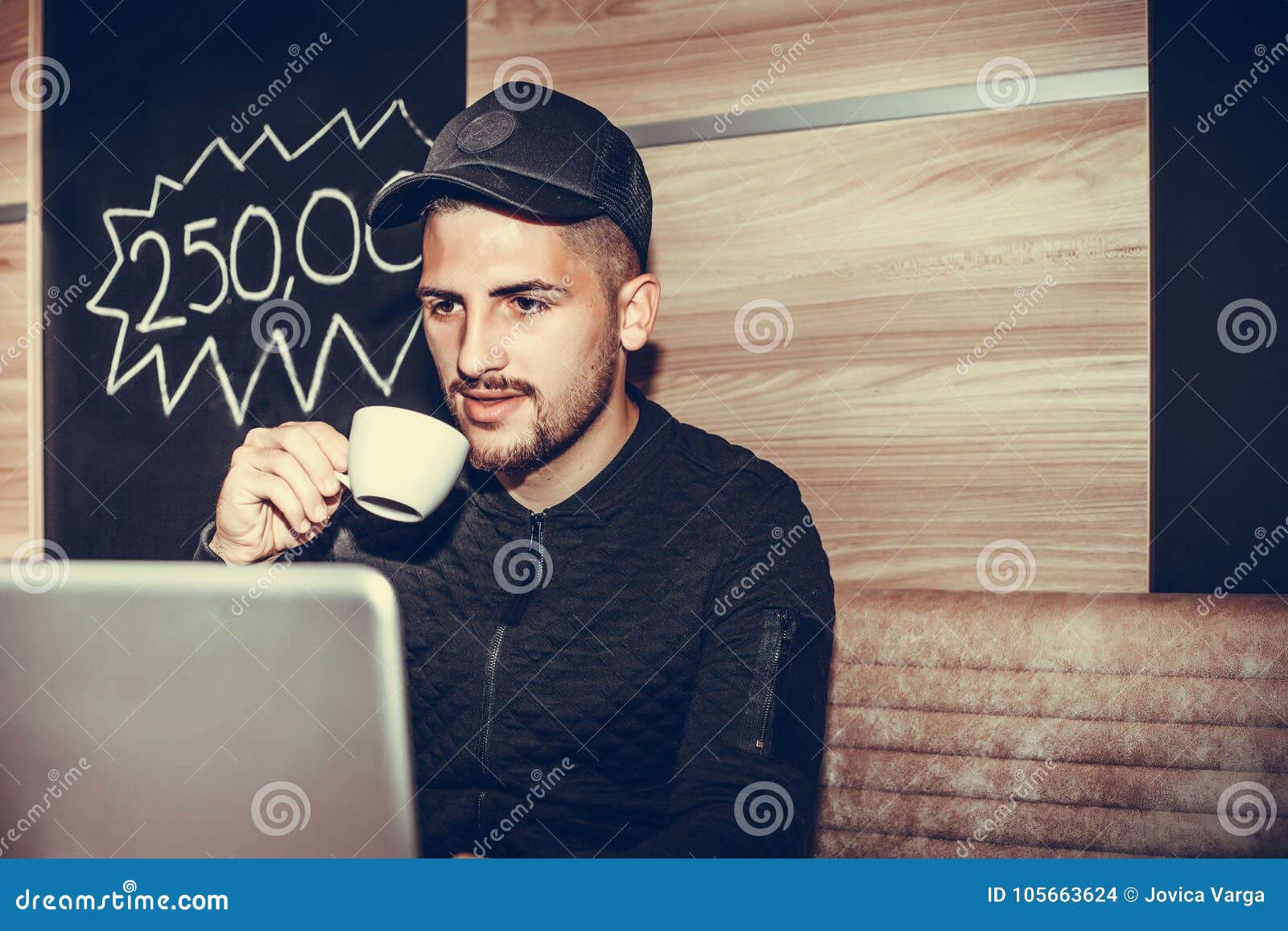 Young Man Using Laptop Computer and Drinking Coffee Stock Photo - Image ...