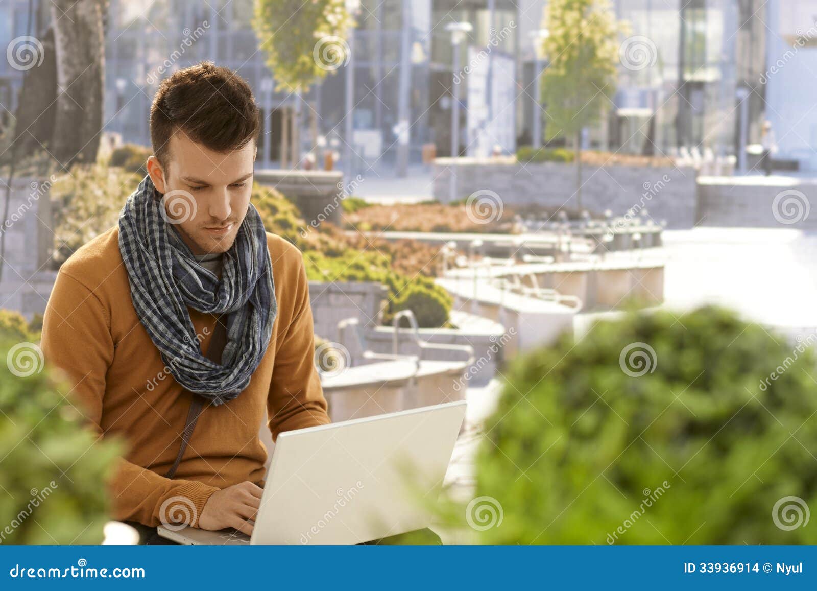 Young Man Using Laptop Computer Outdoors Stock Photo - Image of casual ...