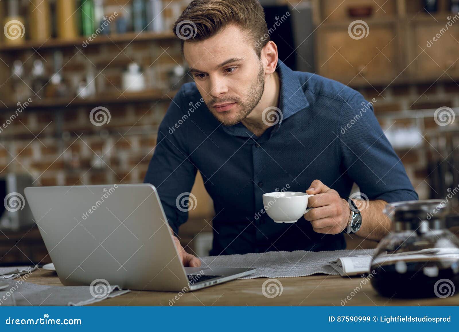 Young Man Using Laptop while Drinking Coffee at Home Stock Image ...