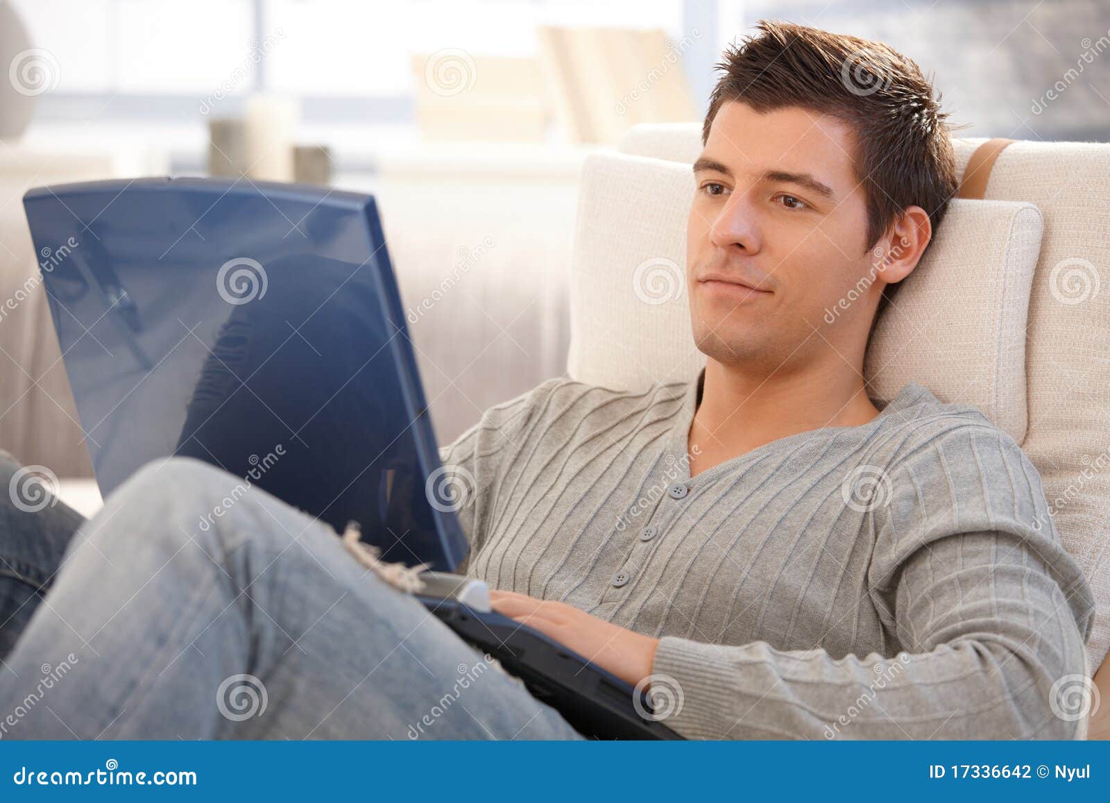 Young Man Using Laptop at Home Stock Photo - Image of male, color: 17336642