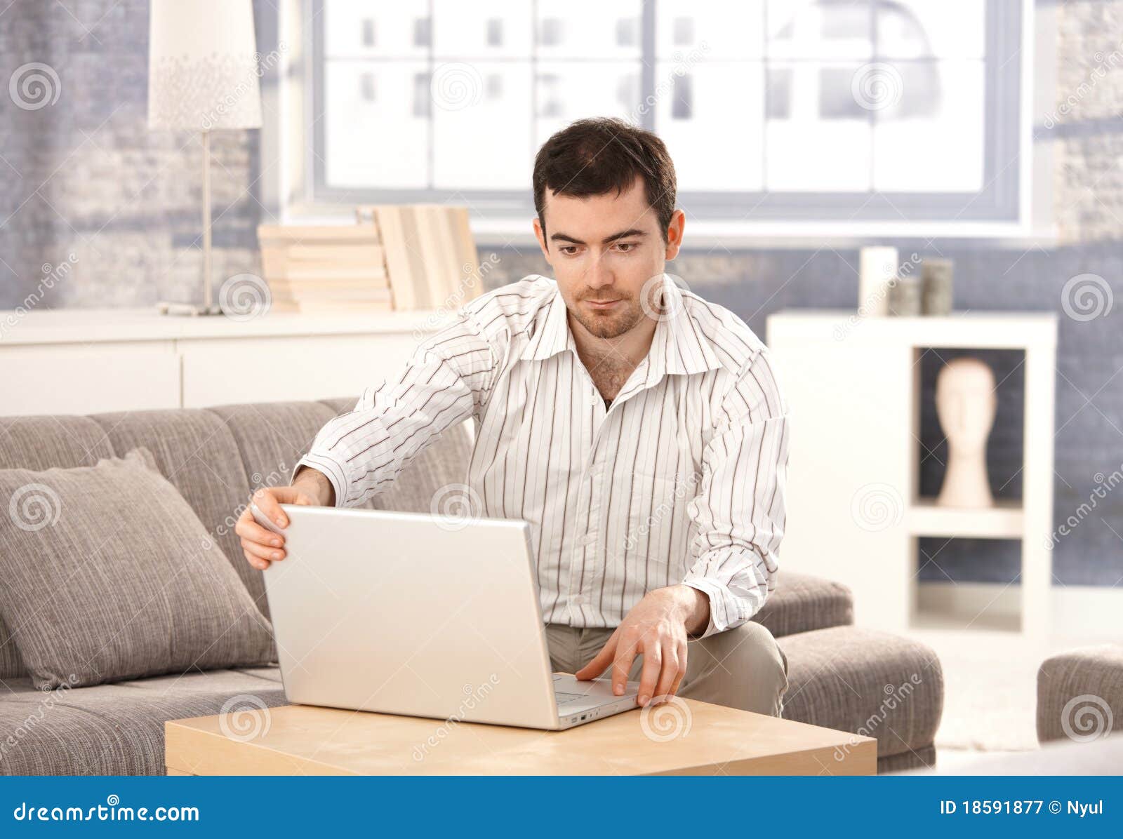 Young Man Using Laptop at Home Sitting on Sofa Stock Image - Image of ...