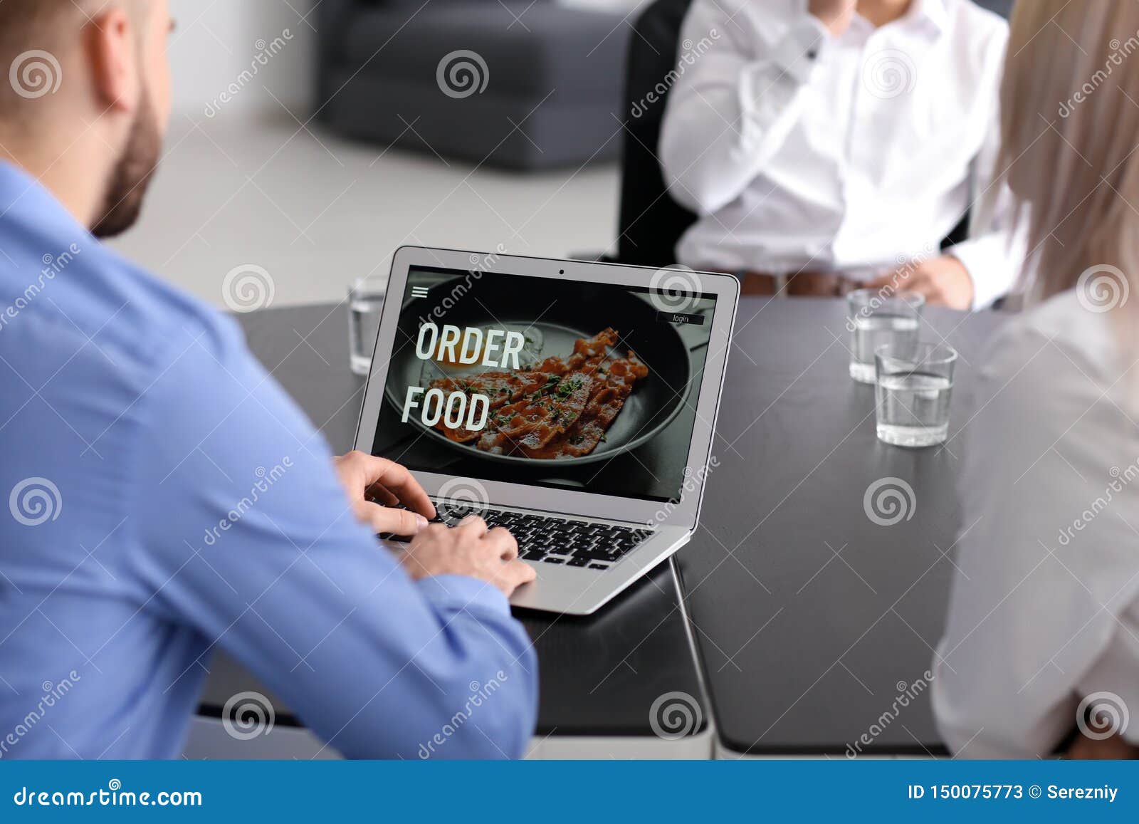 Young Man Using Laptop for Ordering Food in Office Stock Image - Image ...