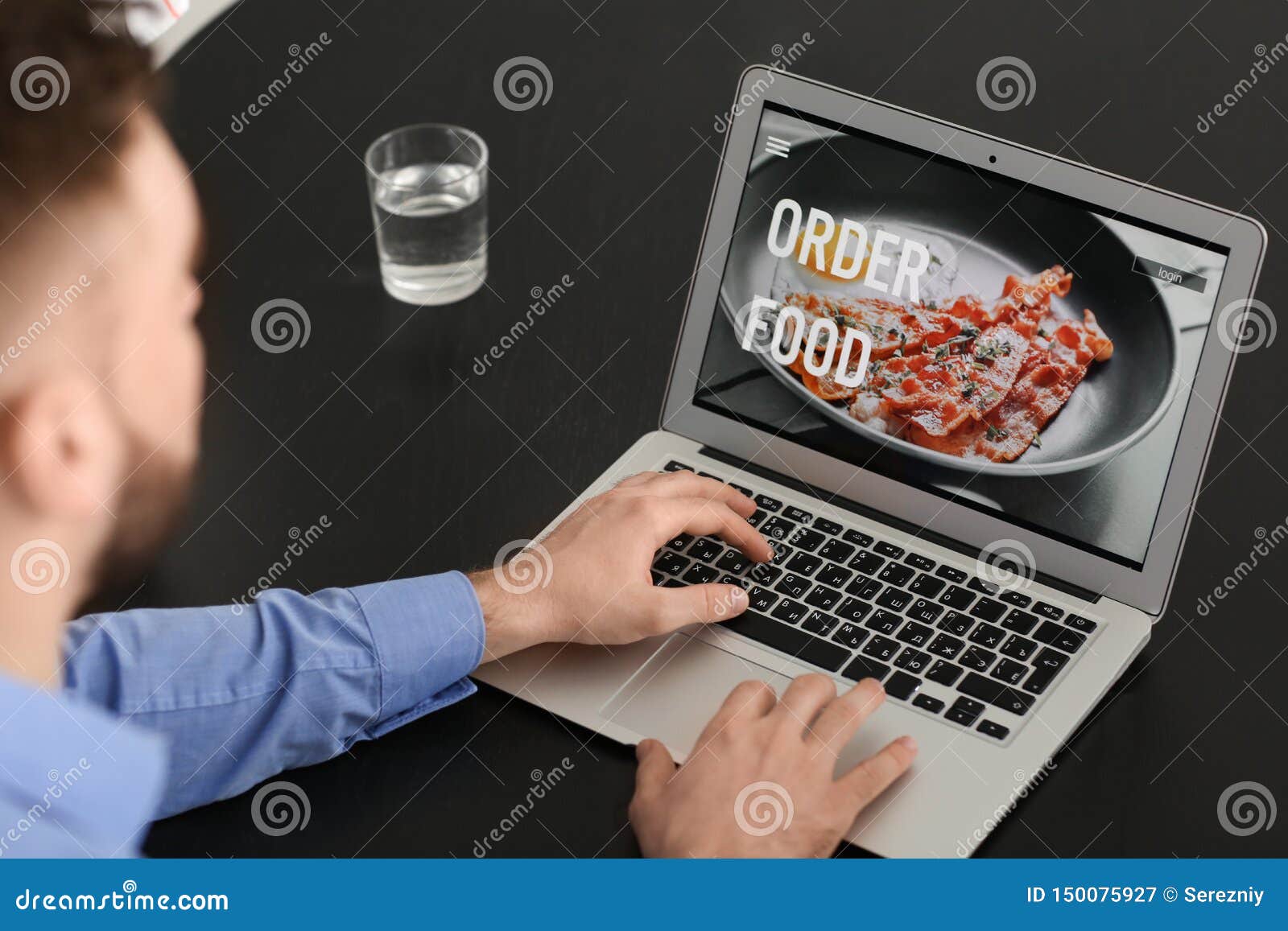Young Man Using Laptop for Ordering Food in Office Stock Image - Image ...