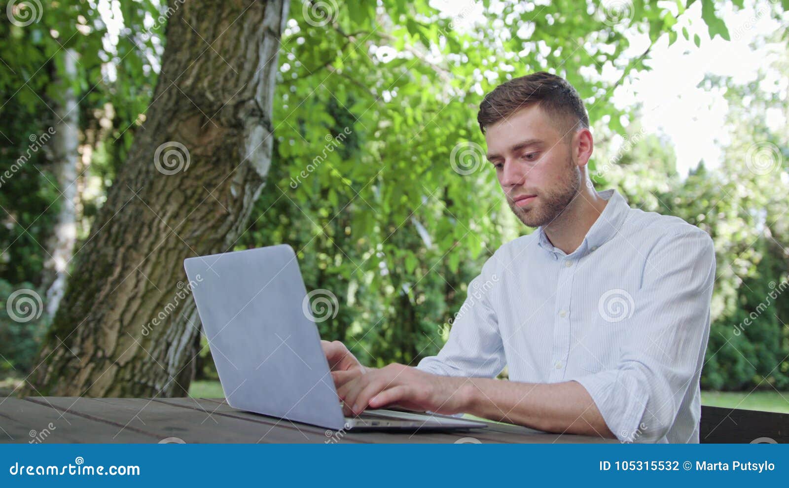 A Young Man Using a Laptop in the Park Stock Photo - Image of outside ...