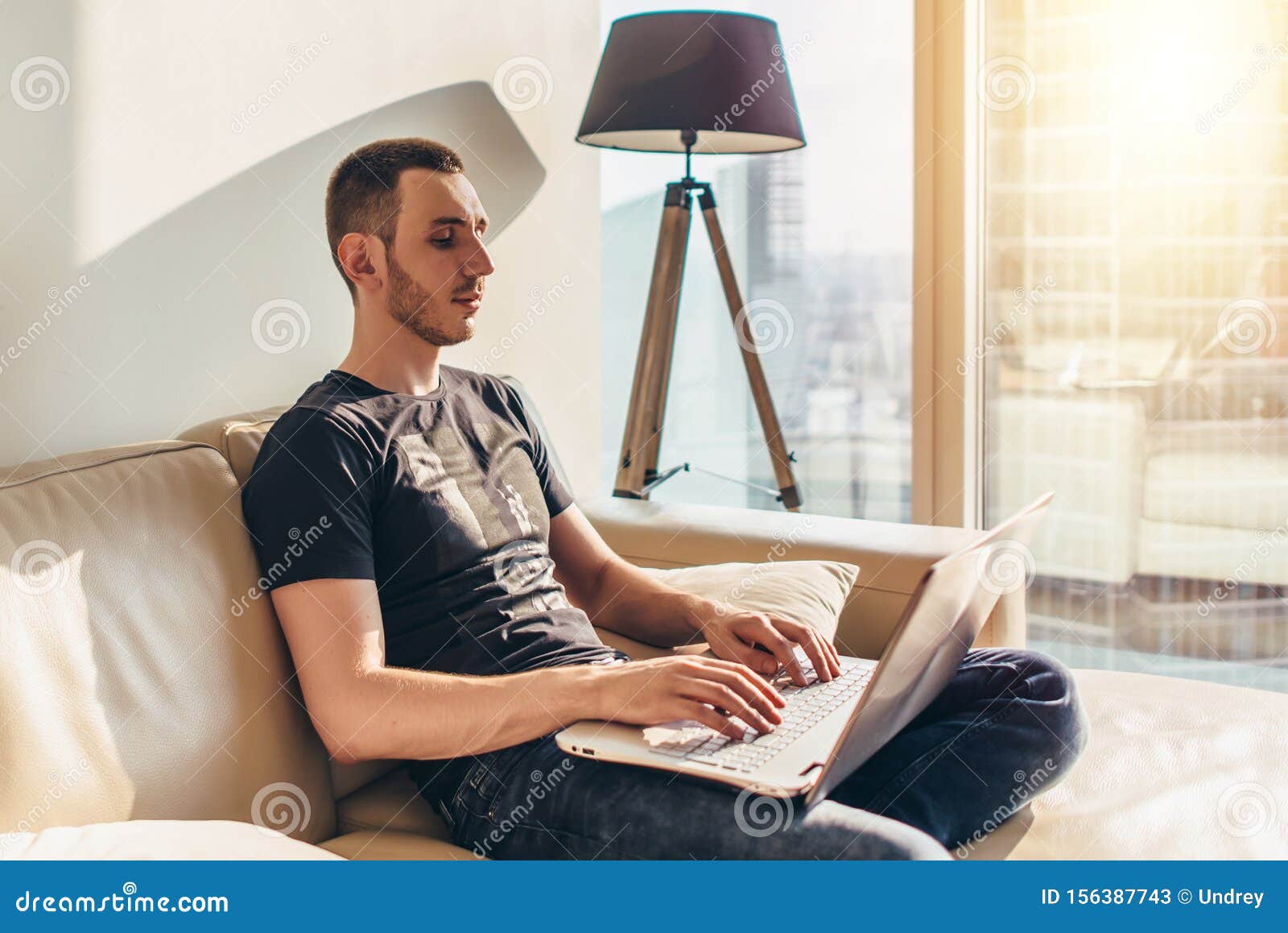 Young Man Using Laptop while Sitting on a Sofa Stock Image - Image of ...