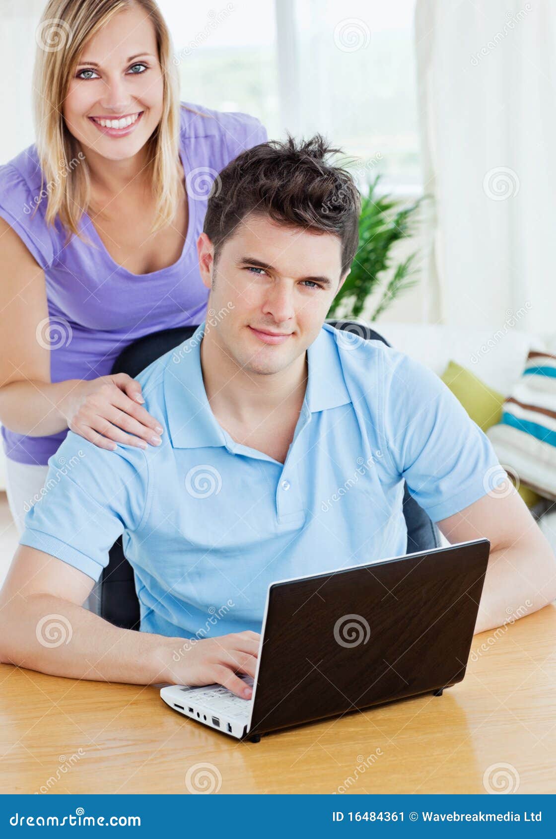 Young Man Using a Laptop Sitting at a Table Stock Image - Image of ...