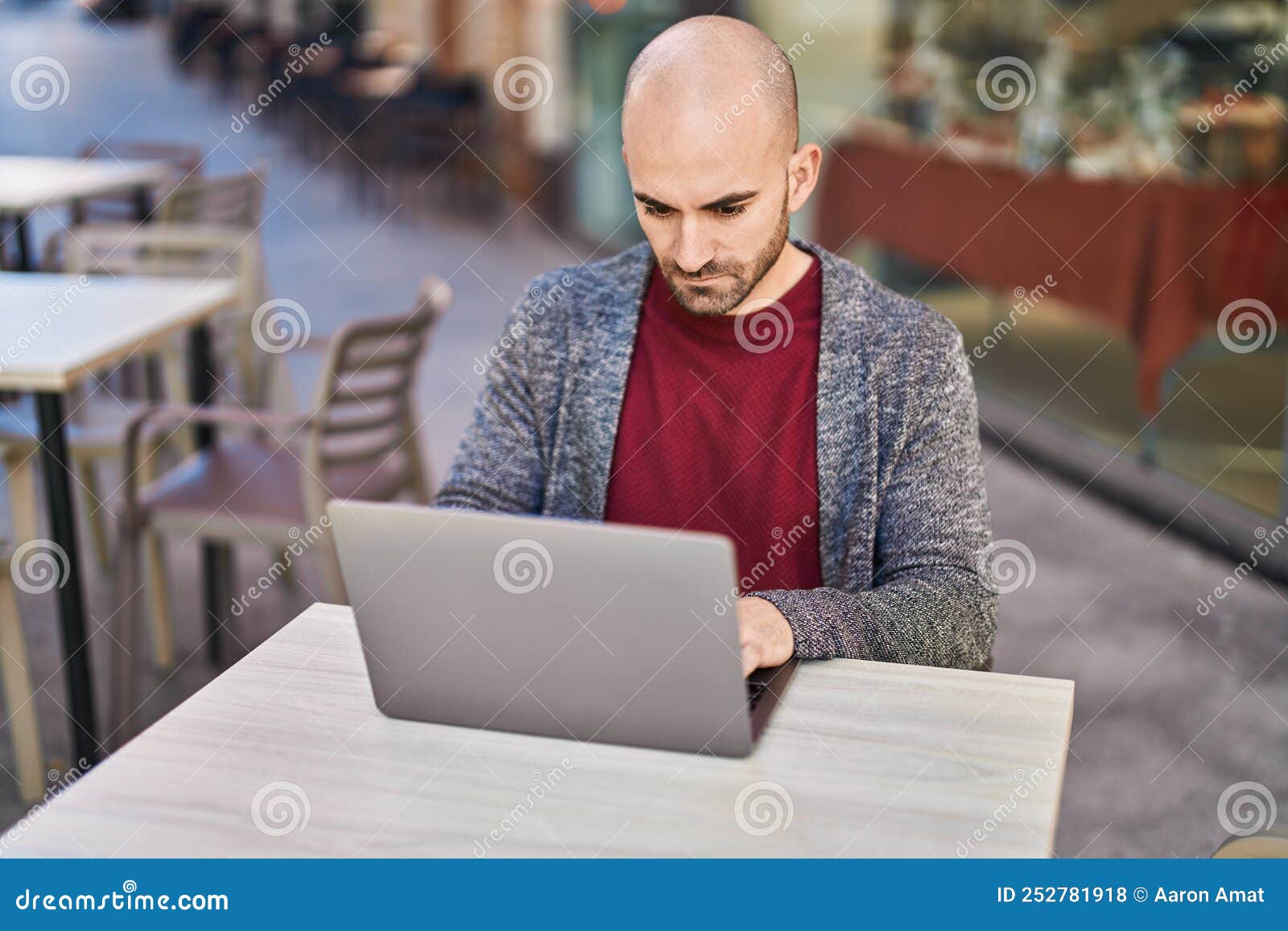 Young Man Using Laptop Sitting on Table at Coffee Shop Terrace Stock ...