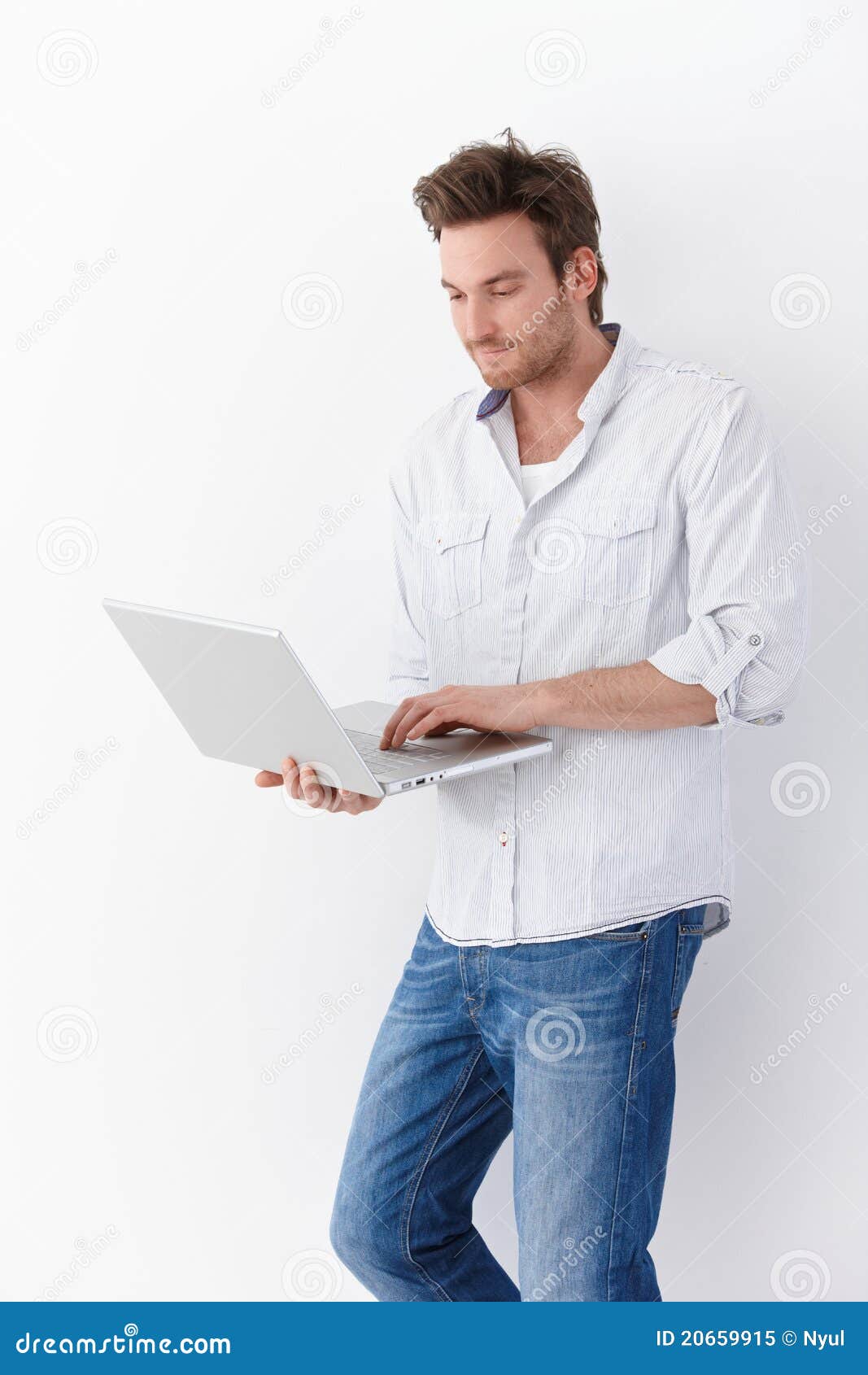 Young Man Using Laptop Standing Smiling Stock Image - Image of busy ...