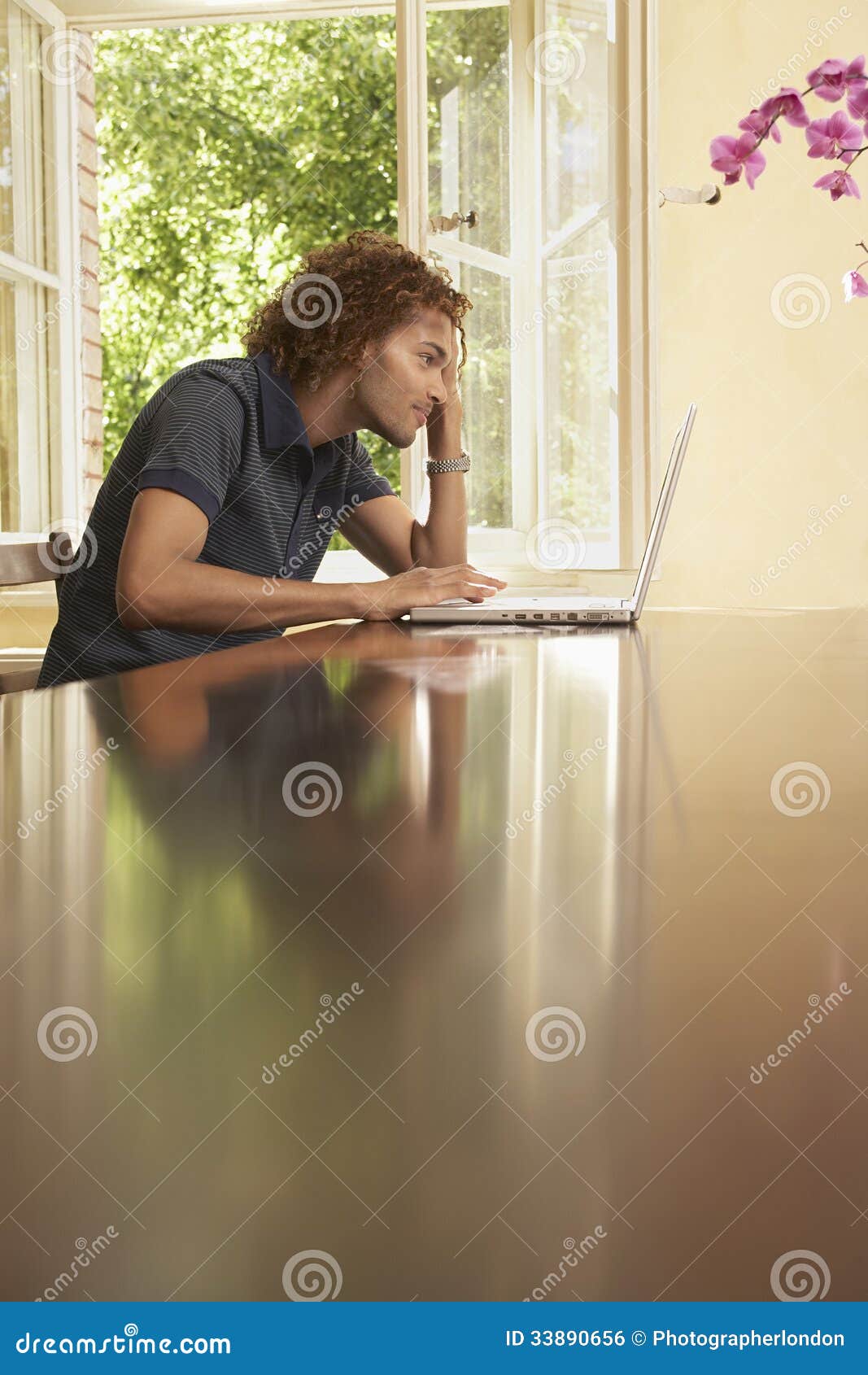 Young Man Using Laptop at Table Stock Photo - Image of home, cool: 33890656