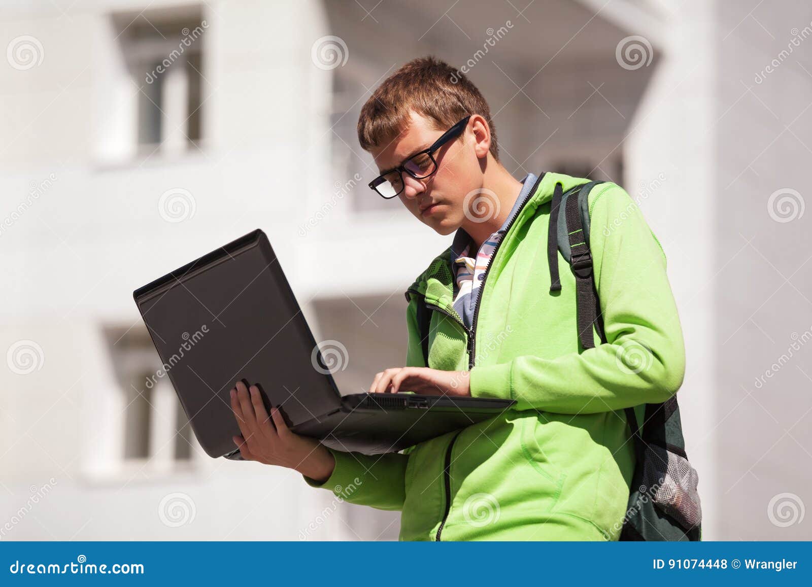 Young Man Using Laptop Walking in City Street Stock Photo - Image of ...